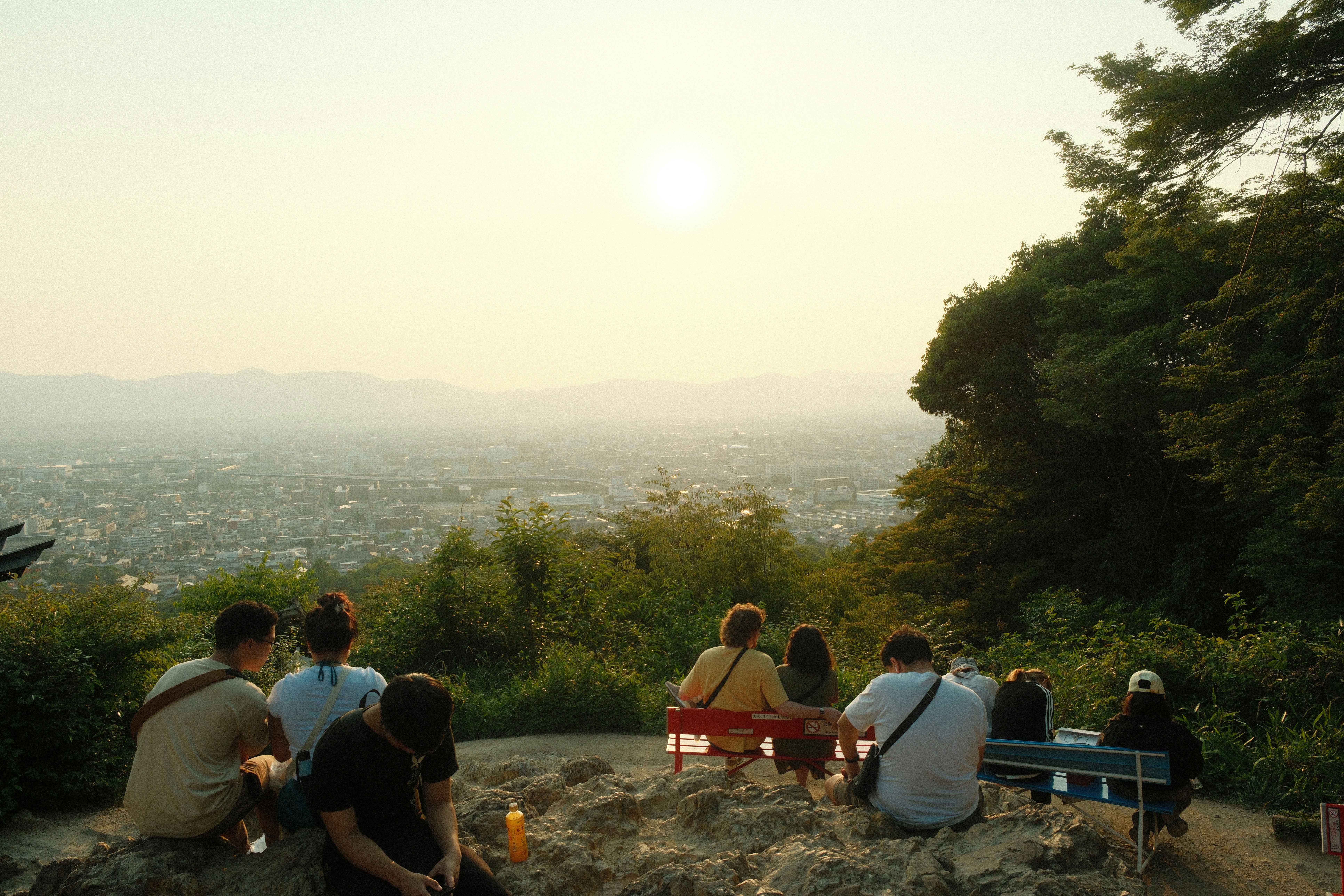 People enjoy the sunset over a city.