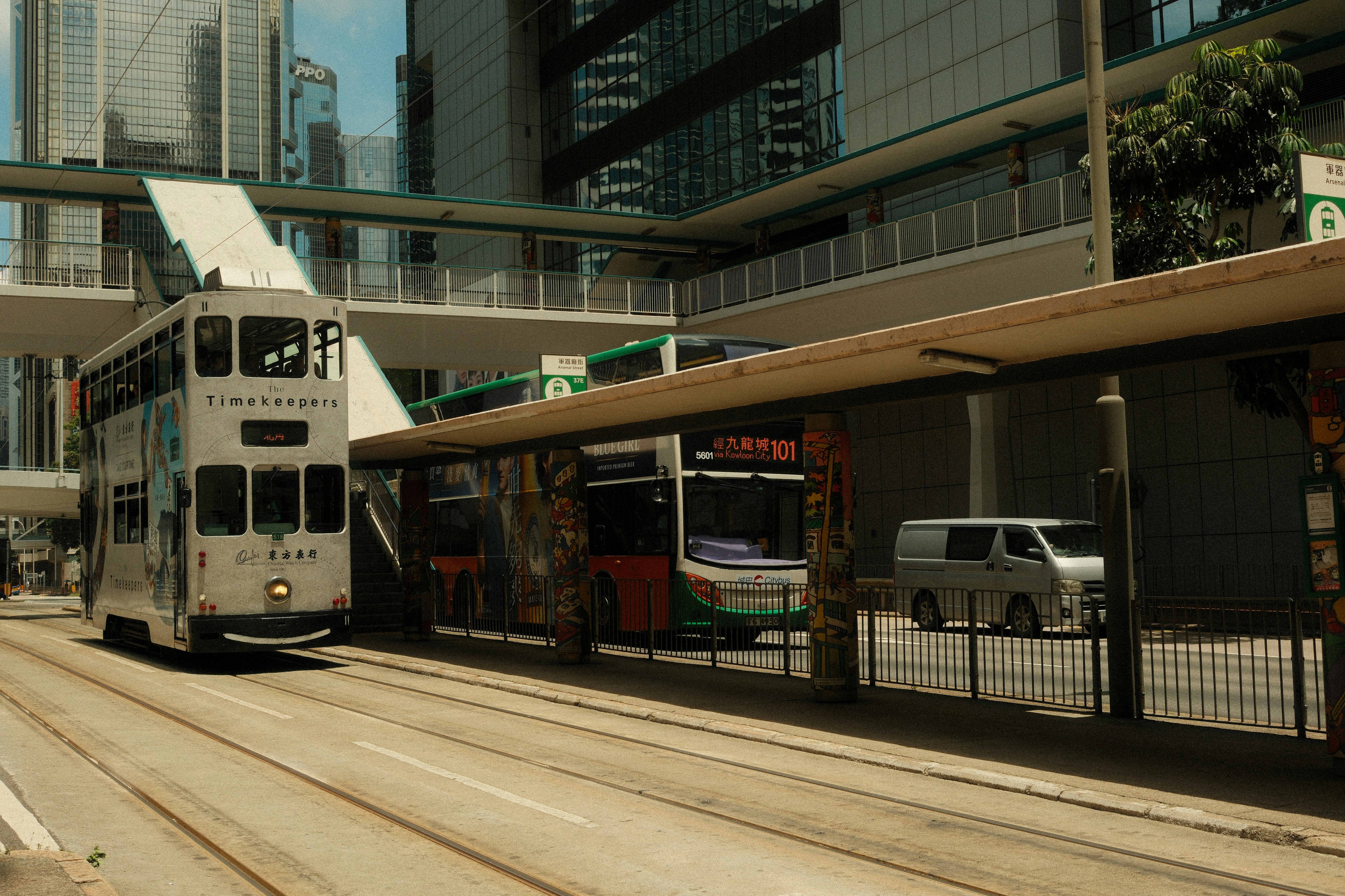 A tram and bus stop in a city.