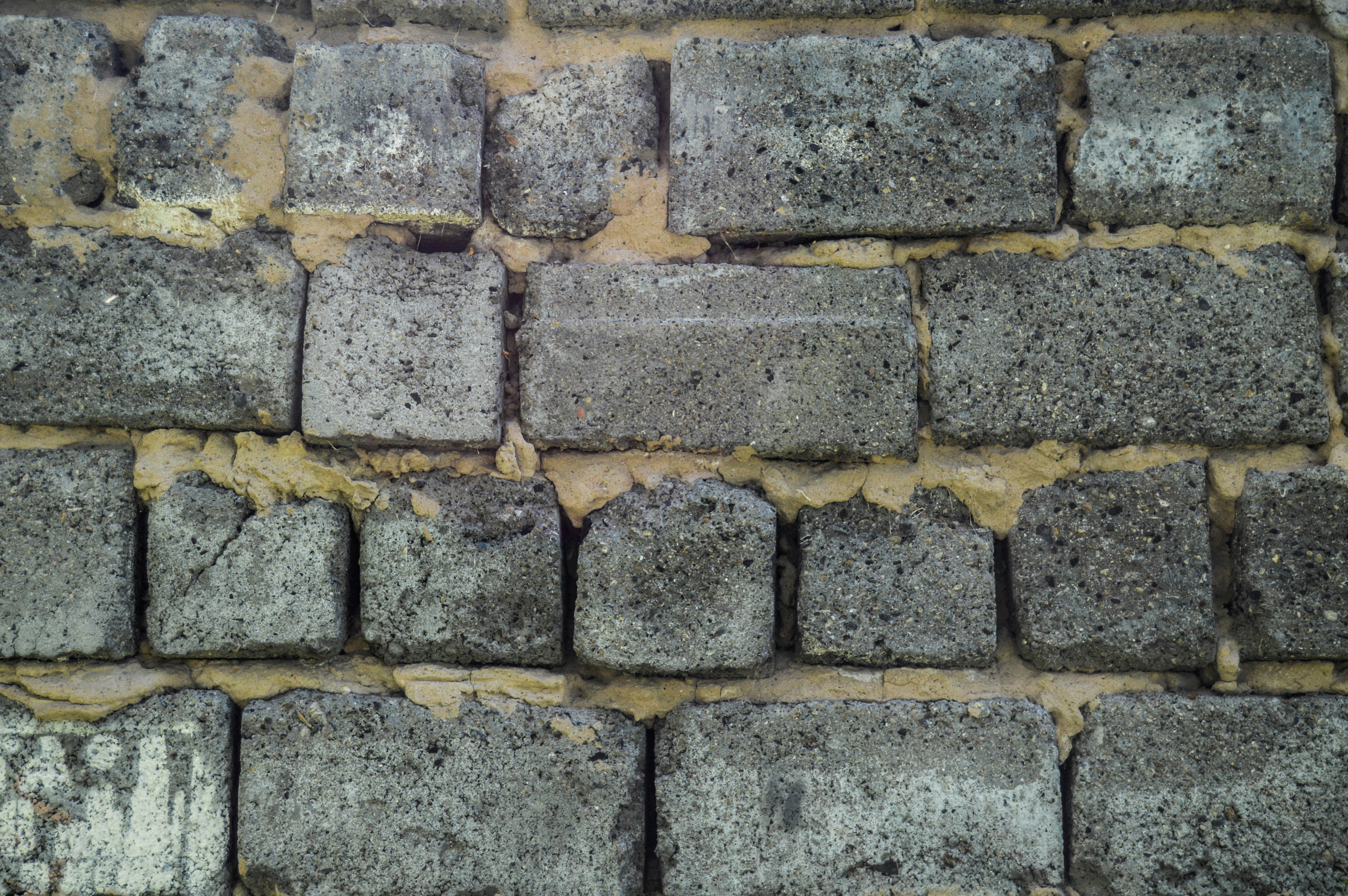 A stone wall with mortar filling the gaps.