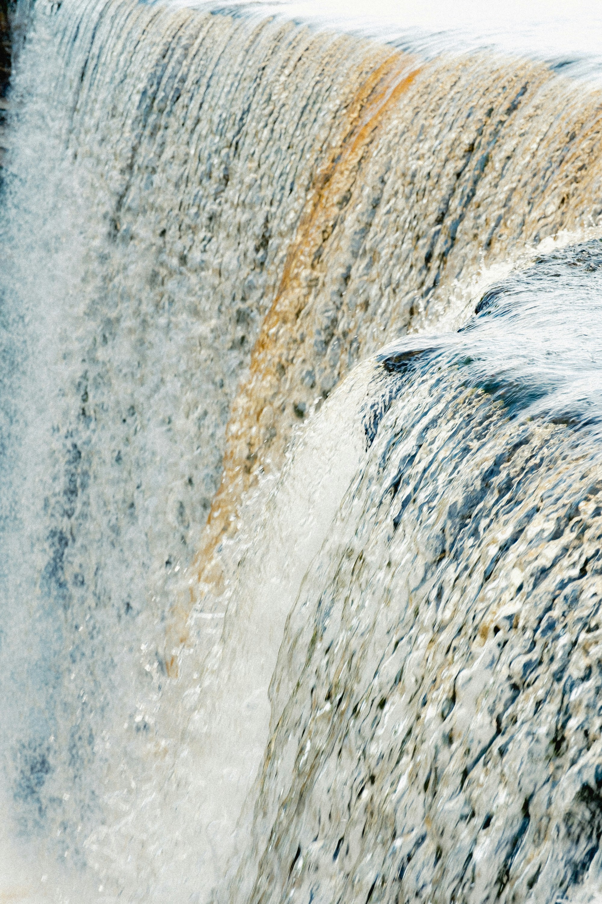 Waterfall's flow cascades over a rocky edge.