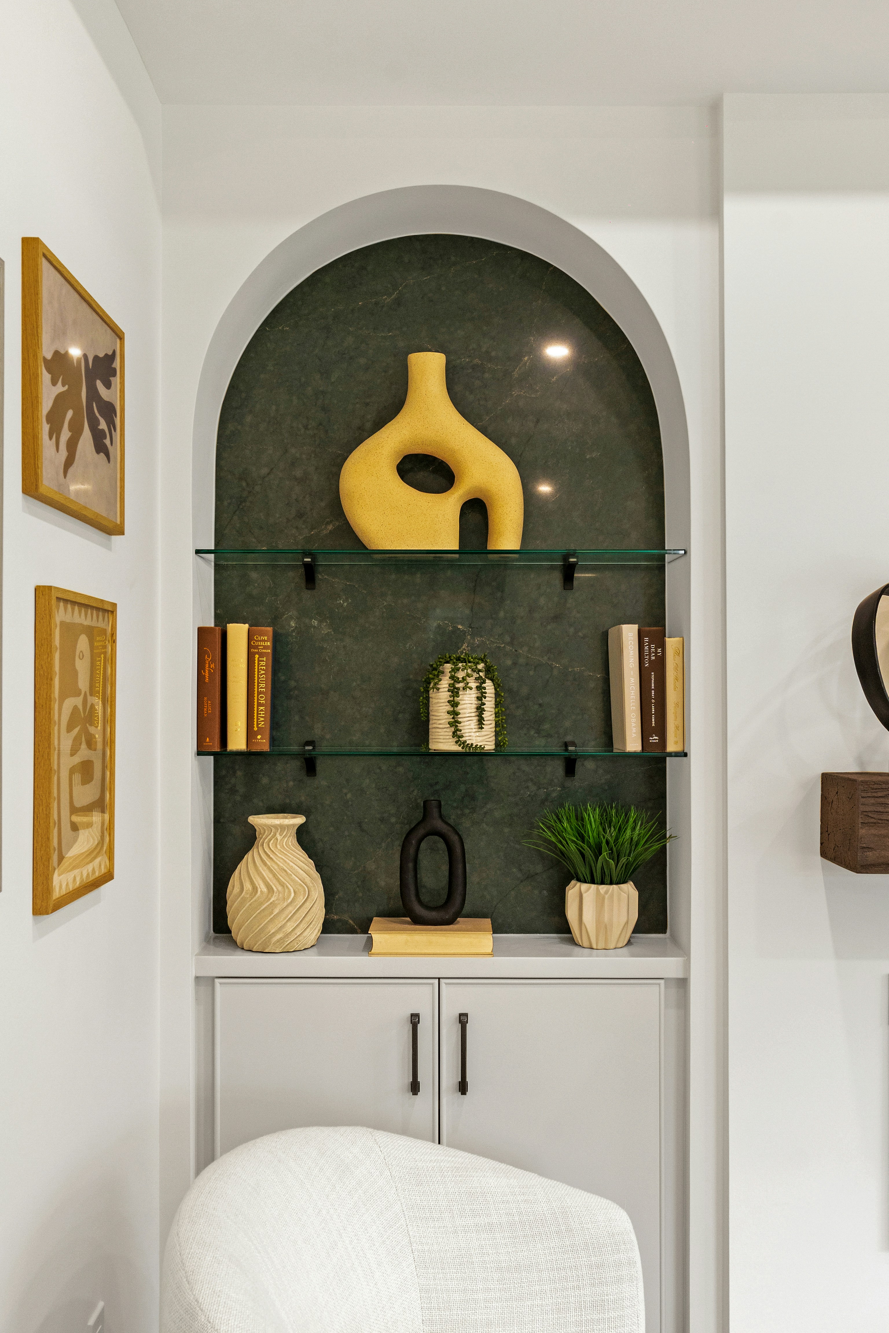 A decorative niche with art and books.