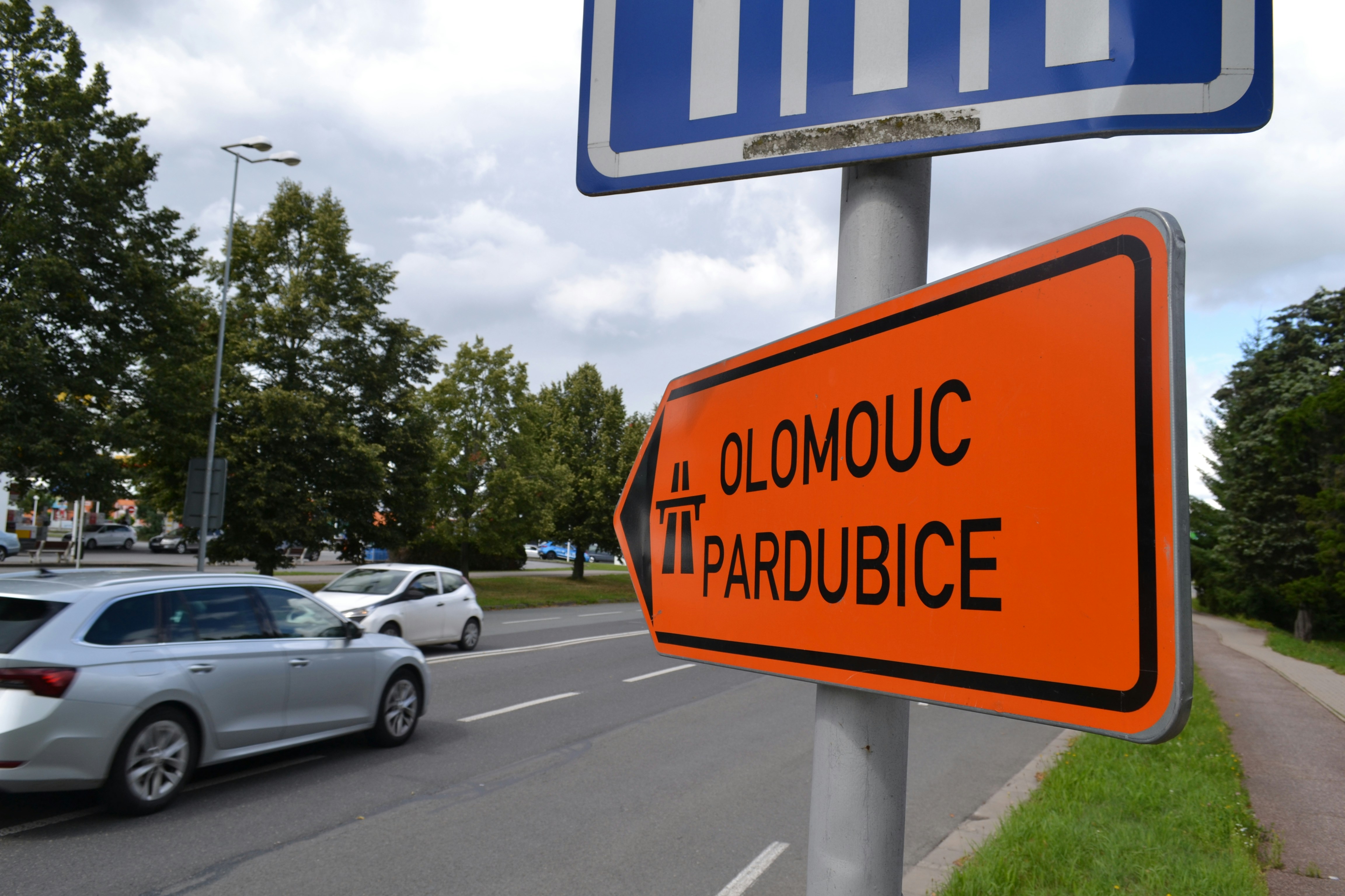 Road sign directs toward olomouc and pardubice.
