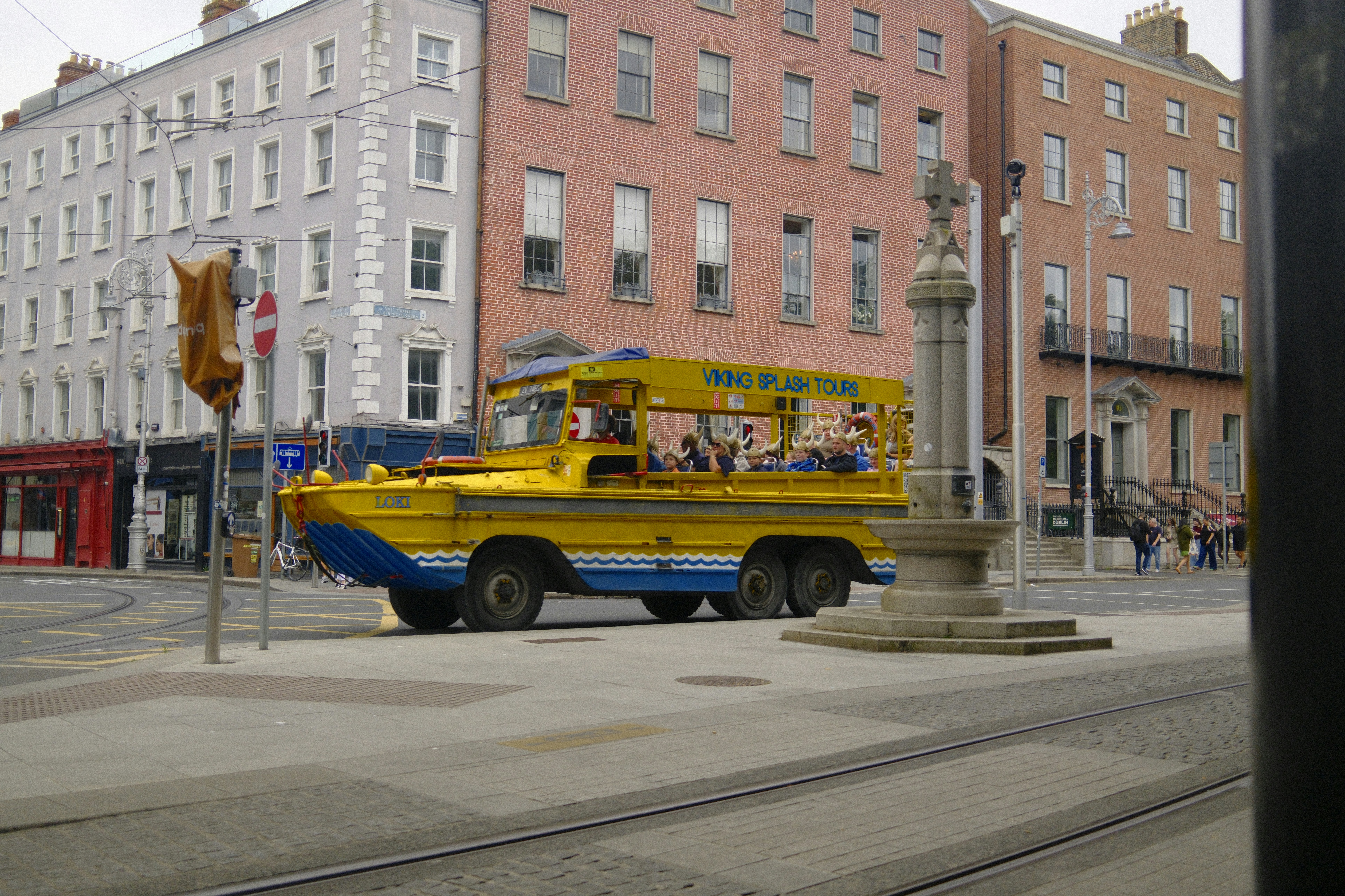 Yellow Amphibious Tour Bus Punctuates a Quiet Tram-Lined City Street
