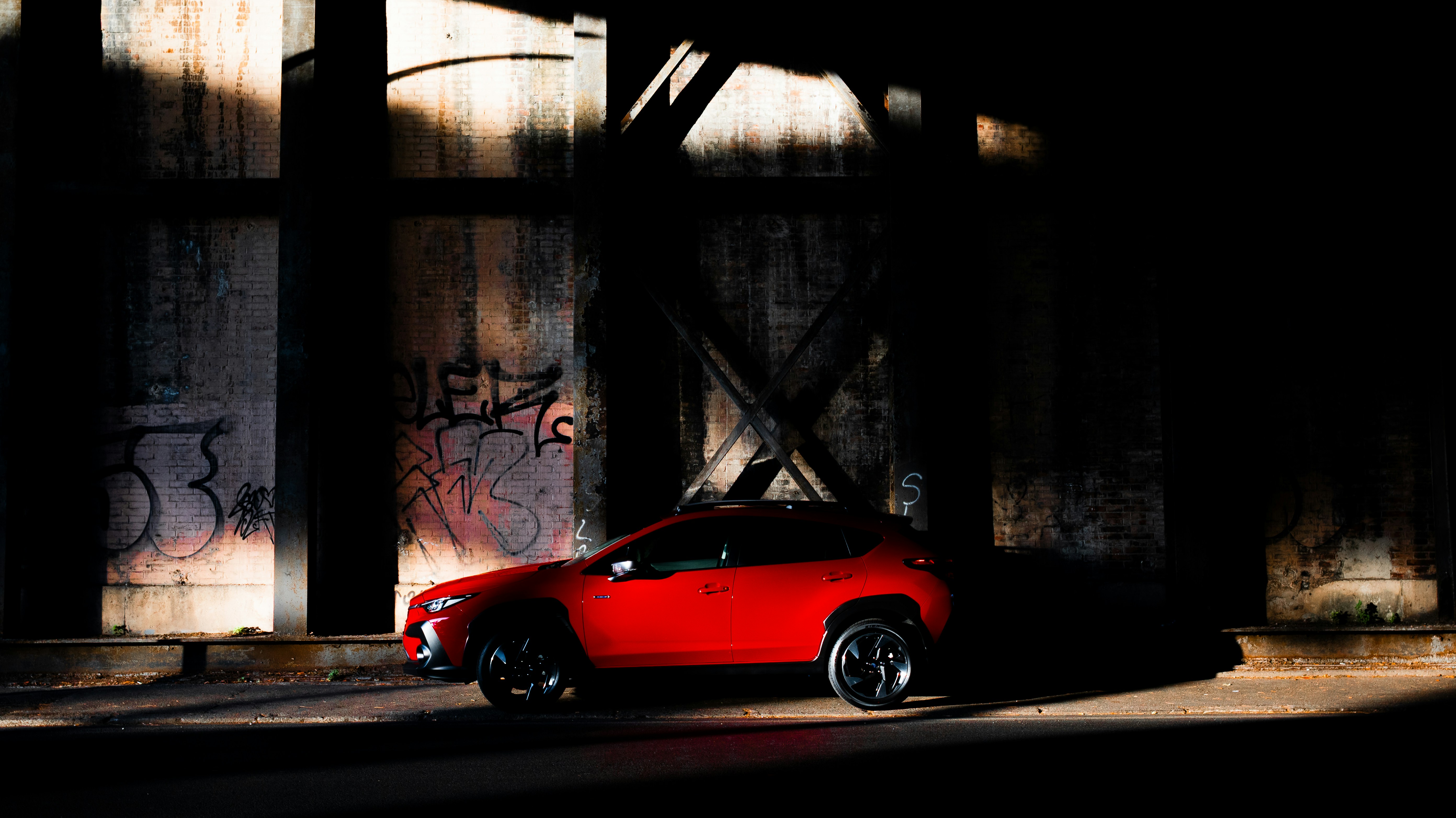 Urban Elegance: A Crimson Cruiser in Shadows