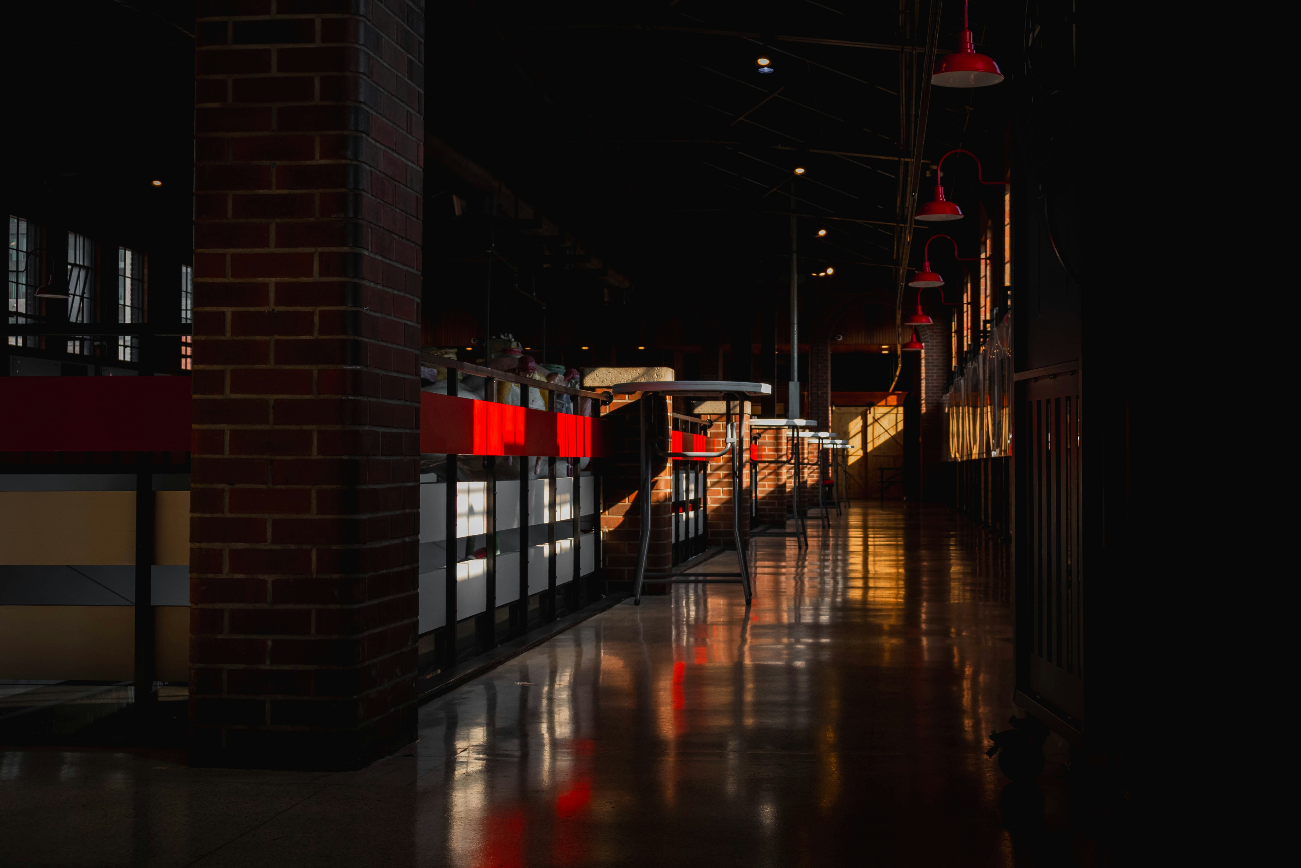 Industrial market interior bathed in warm afternoon light. | A dimly lit interior hallway.