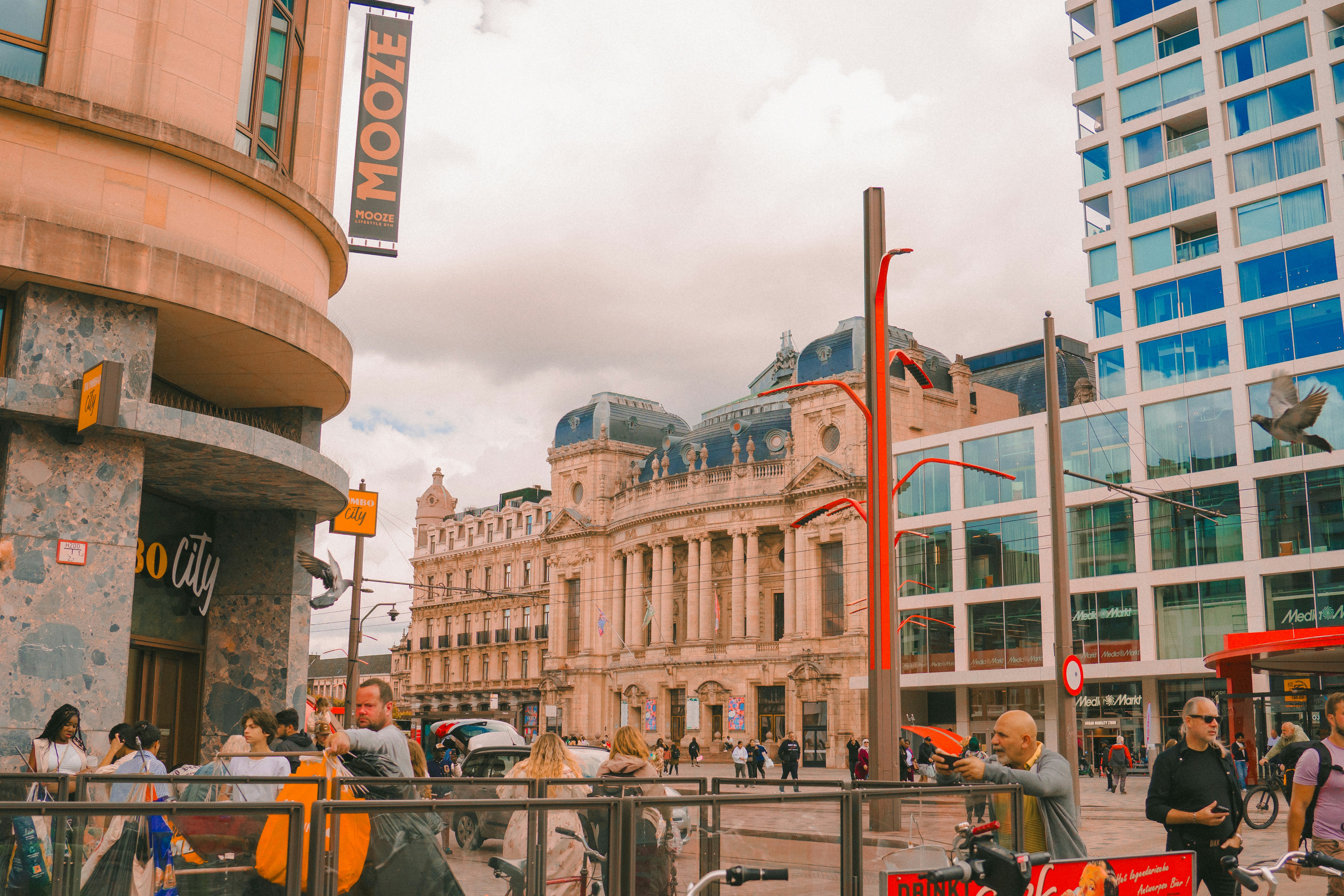 Buildings and people populate a city street.