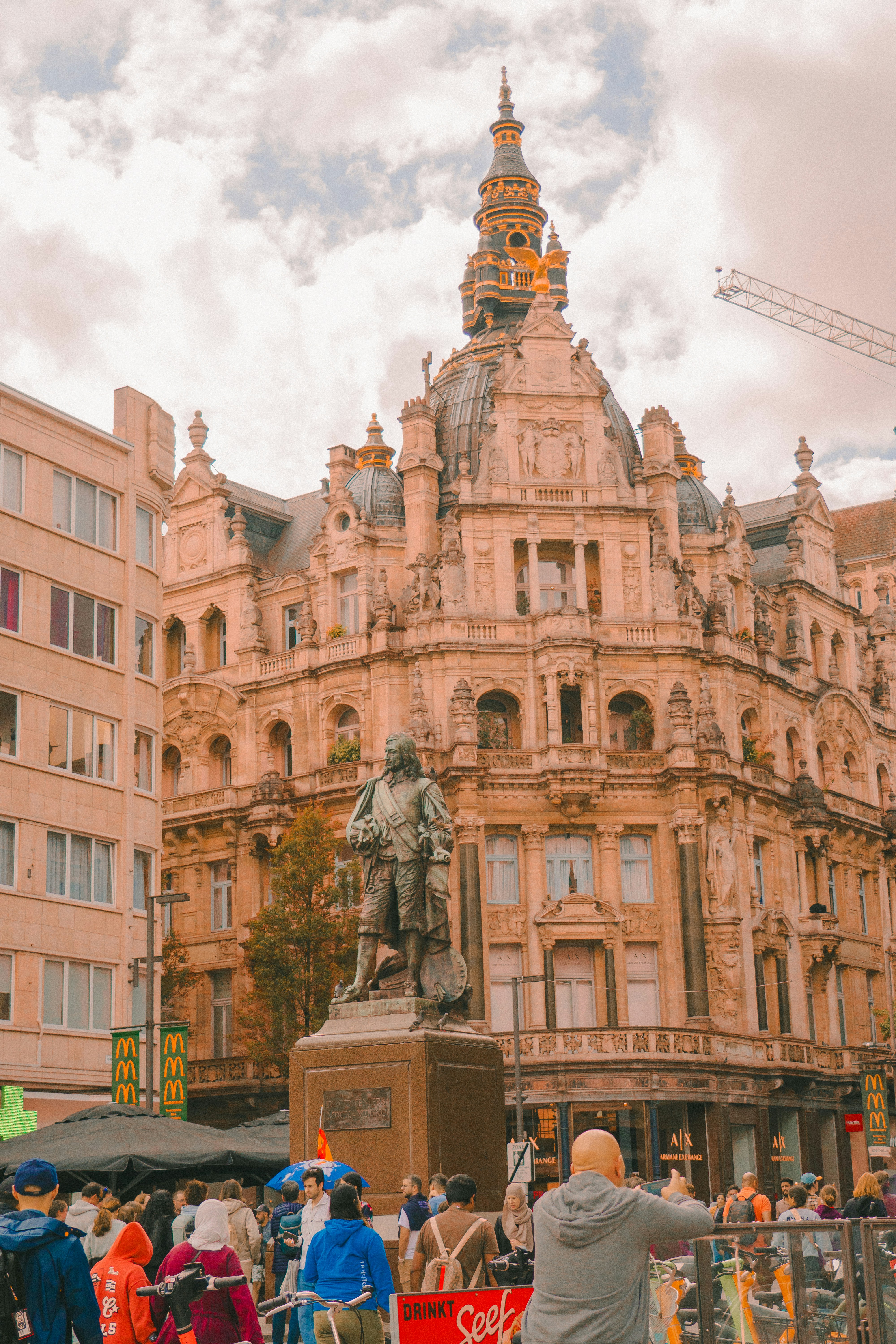 Ornate building stands tall with a statue.