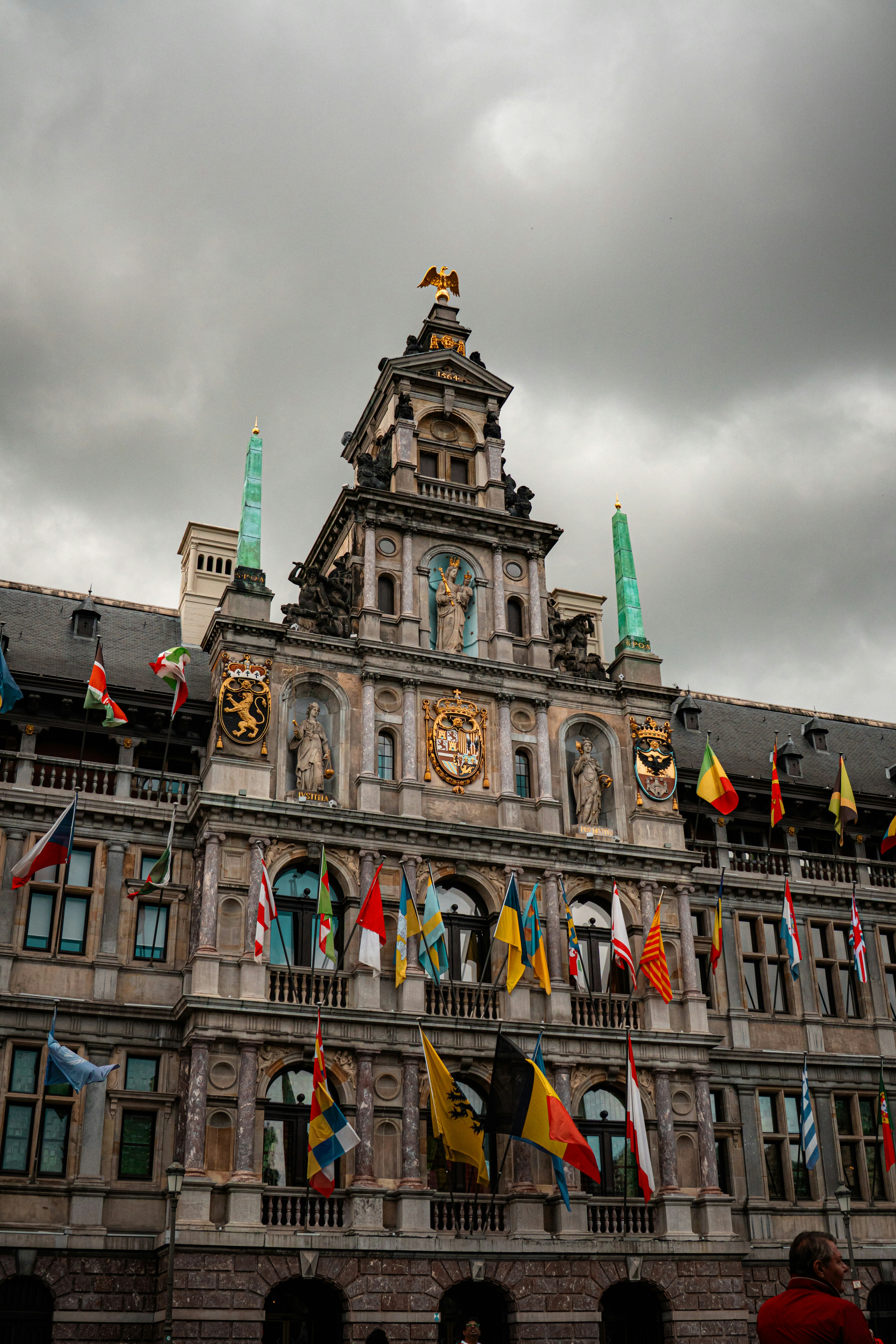 A grand building adorned with flags.