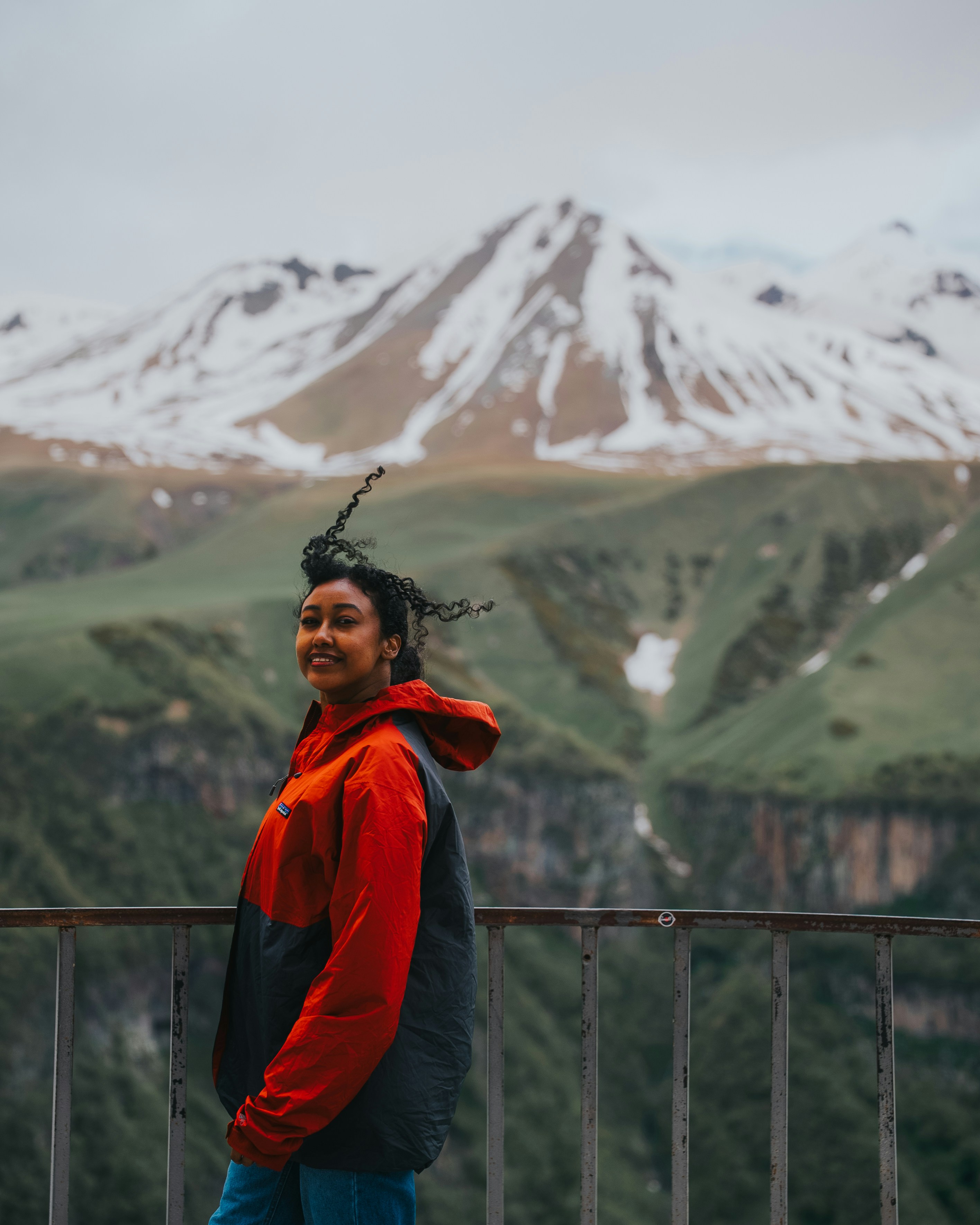 Crimson Portrait on a Wind-Swept Alpine Balcony