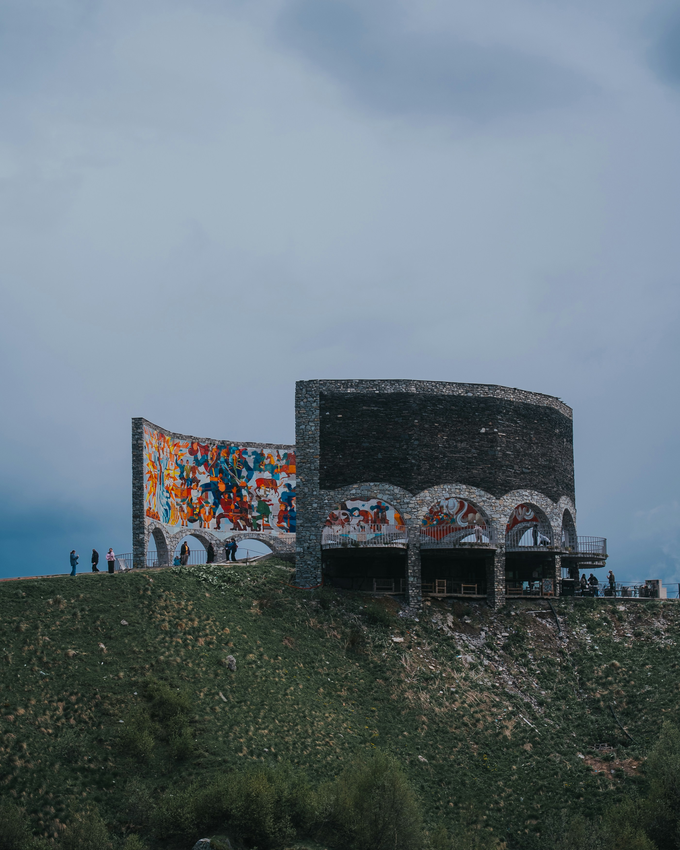 A monument stands on a hill under overcast skies.