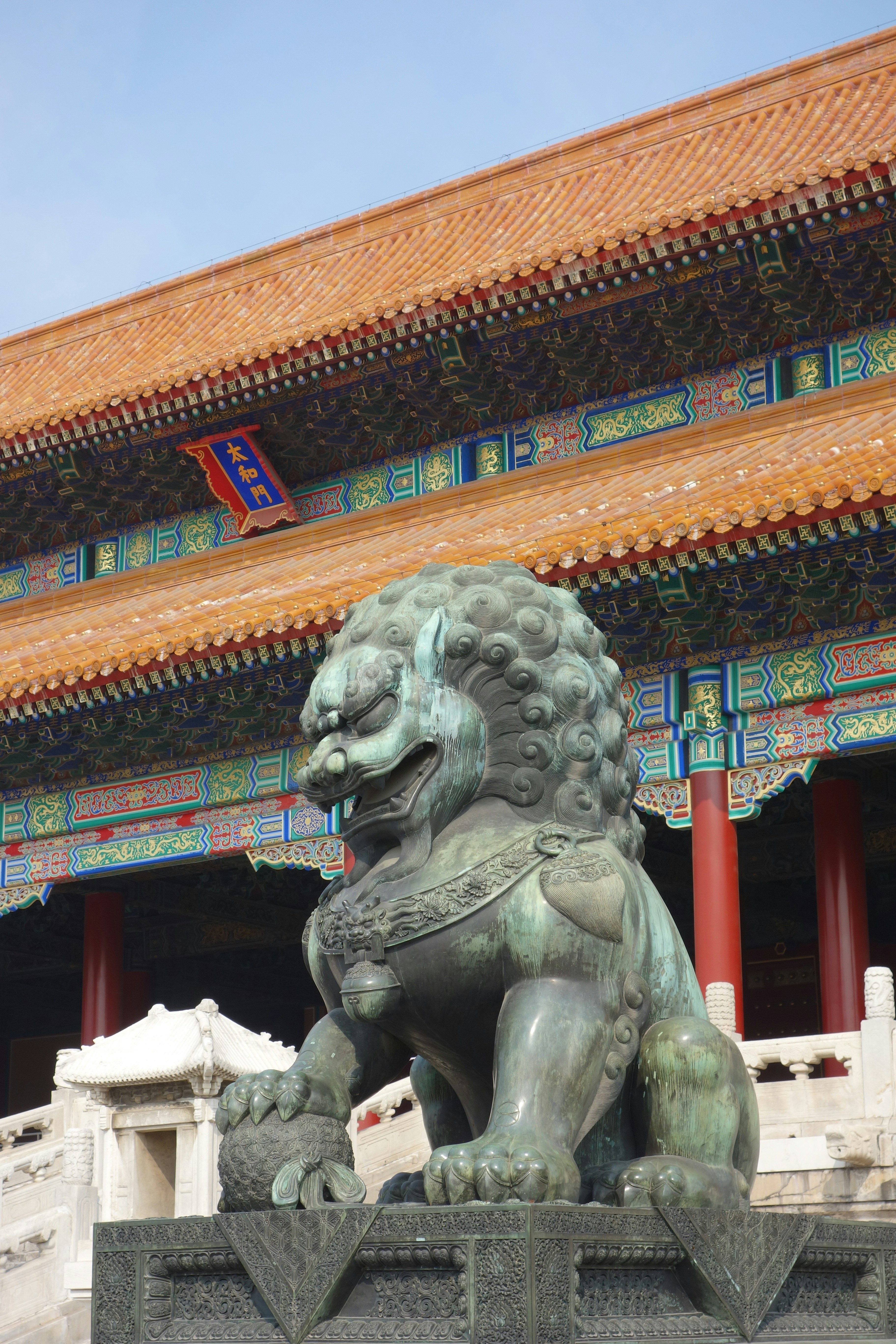 Bronze Guardian Under Painted Eaves: A Lion at the Temple's Threshold