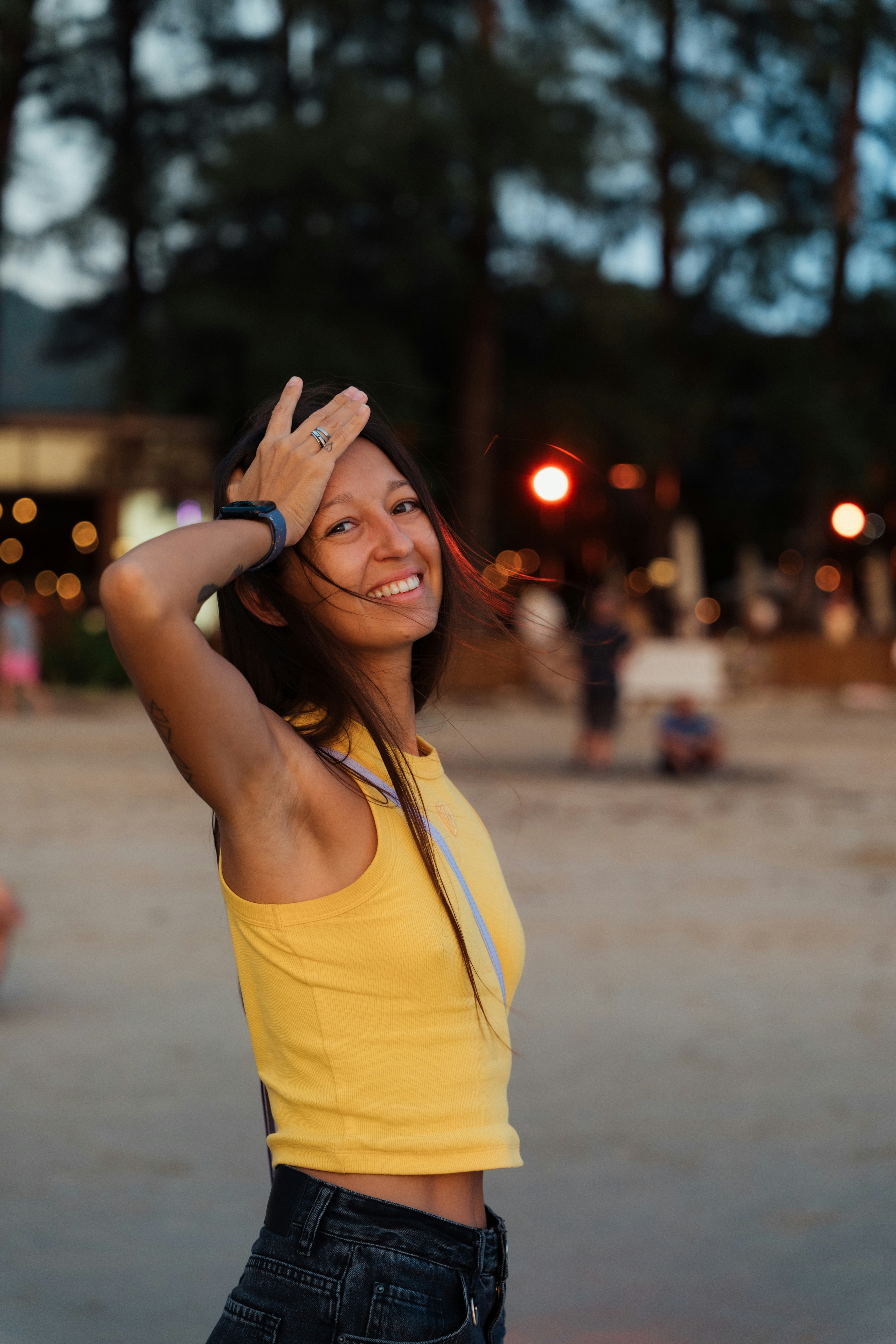 Golden Hour Grin: A Yellow-Top Portrait by the Plaza Lights