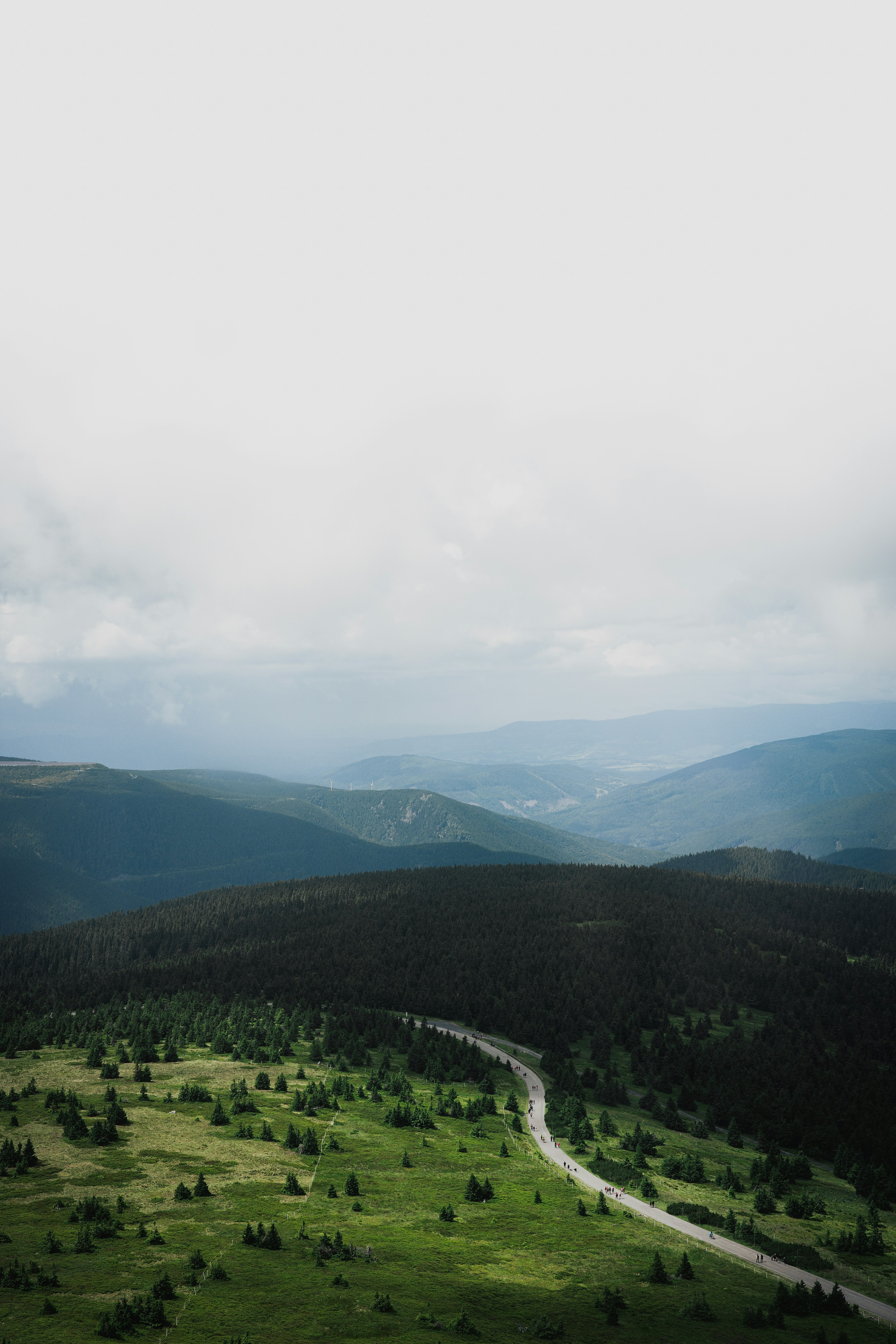A winding road curves through mountains.