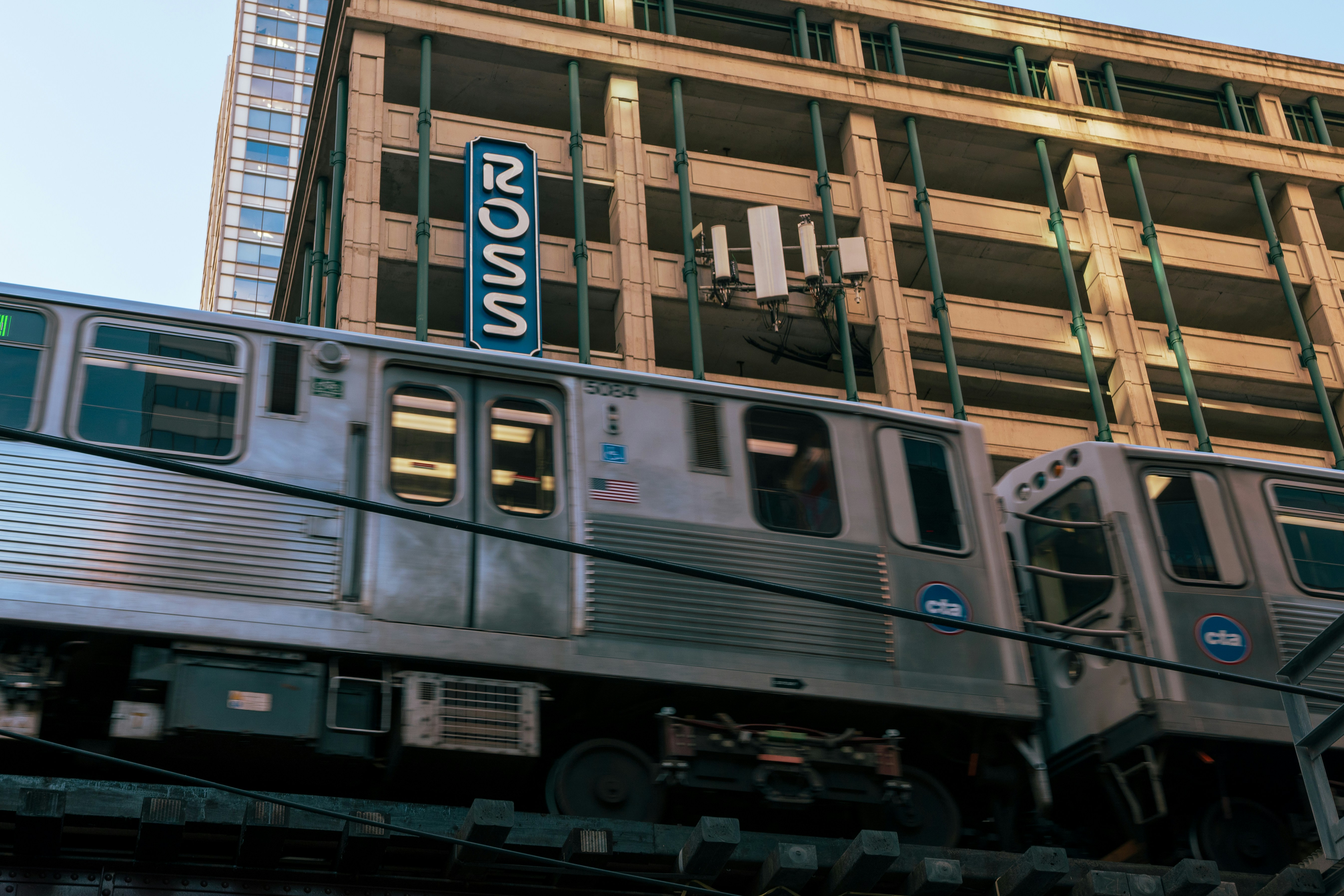 A train rides past a ross store.