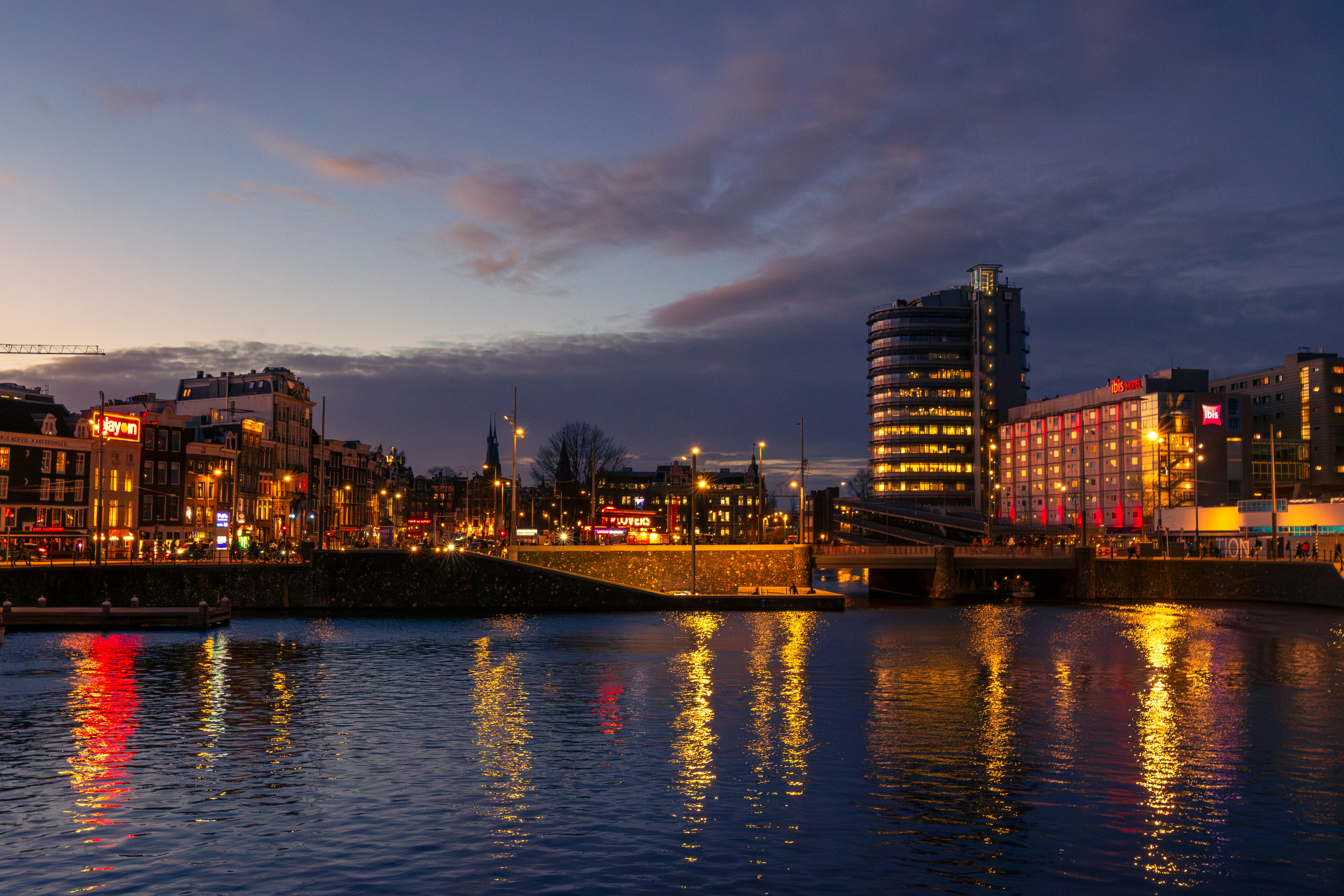 City lights reflect beautifully in the calm water.