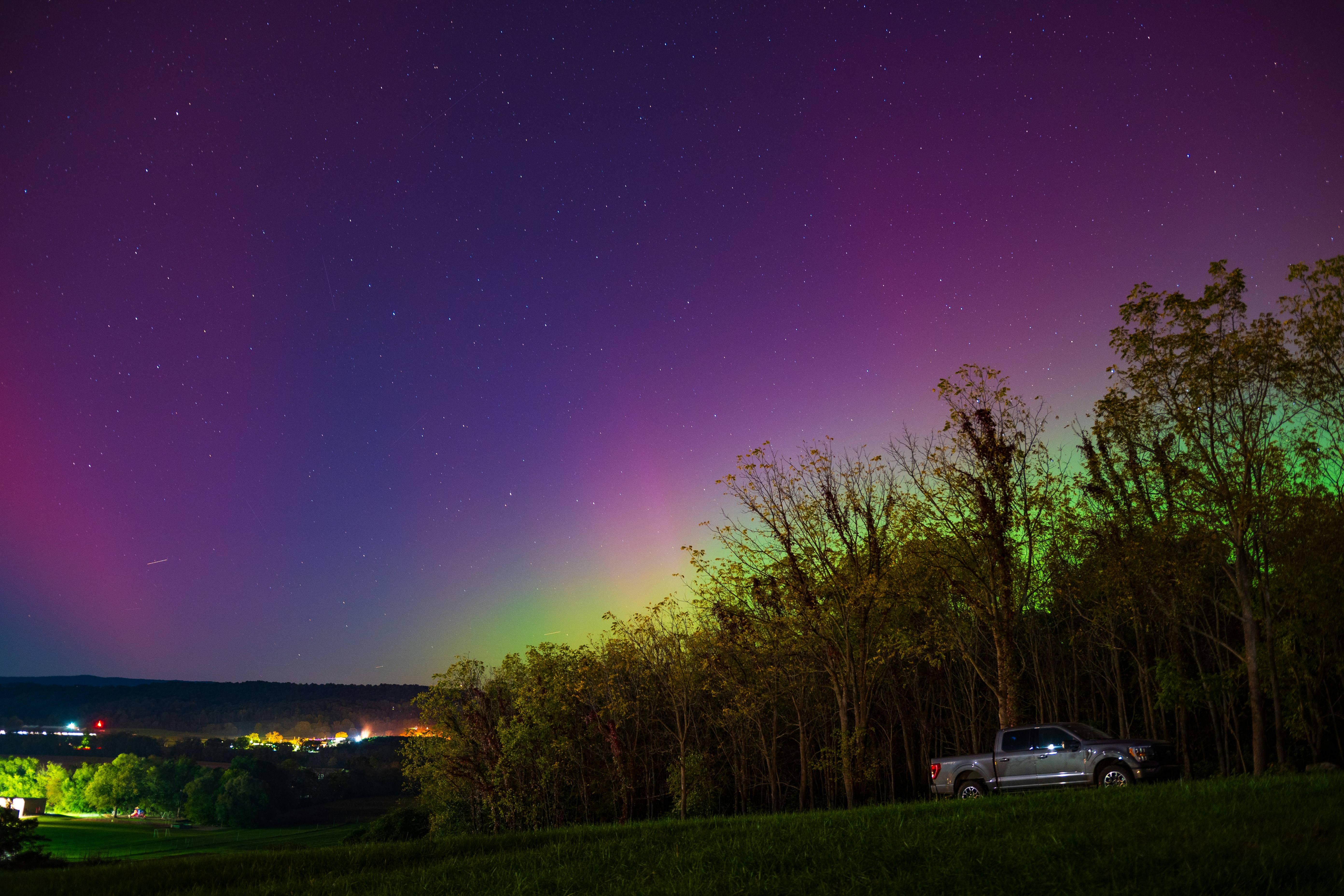 Aurora borealis glows above the landscape.