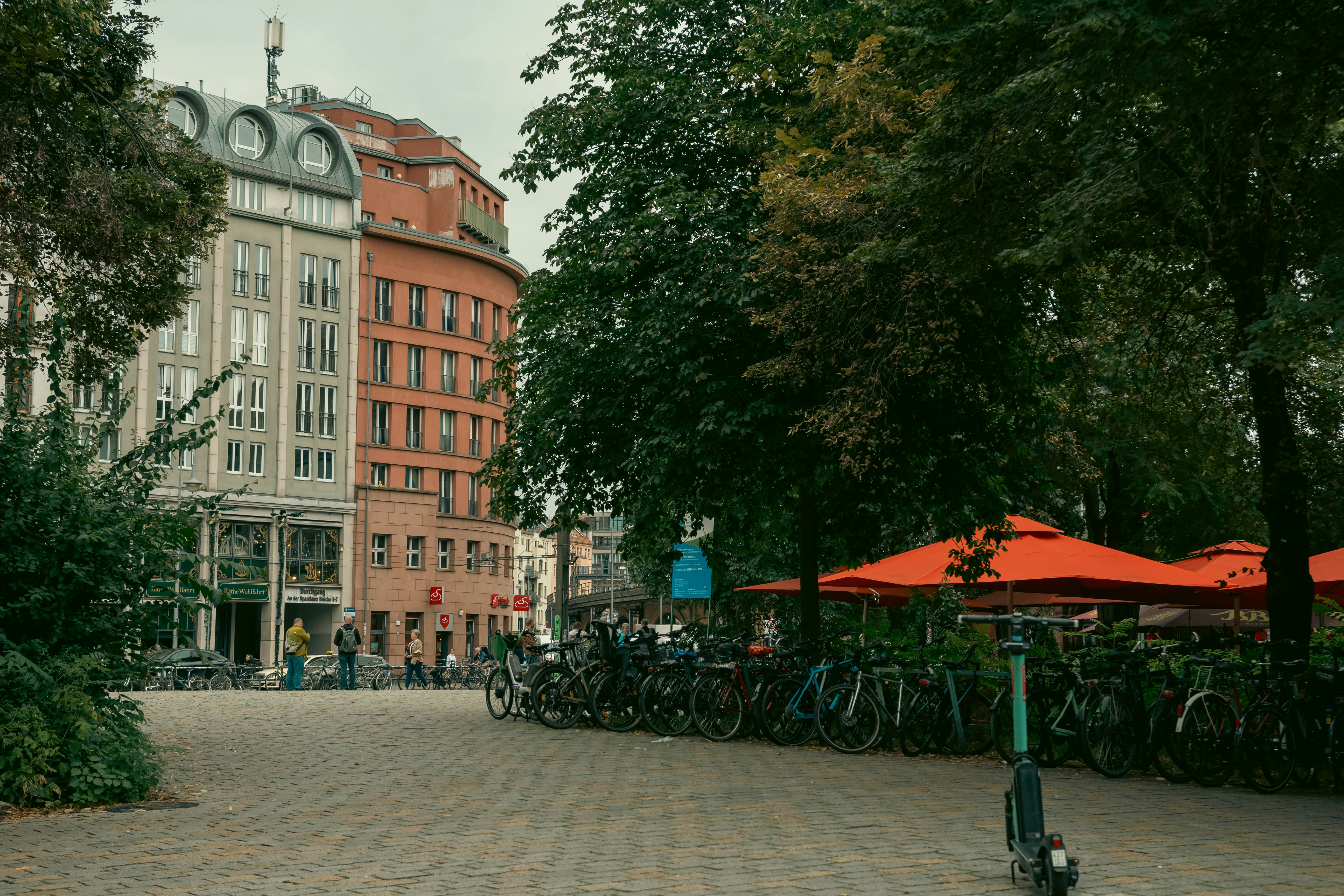 Buildings and bikes line a walkway in the city.