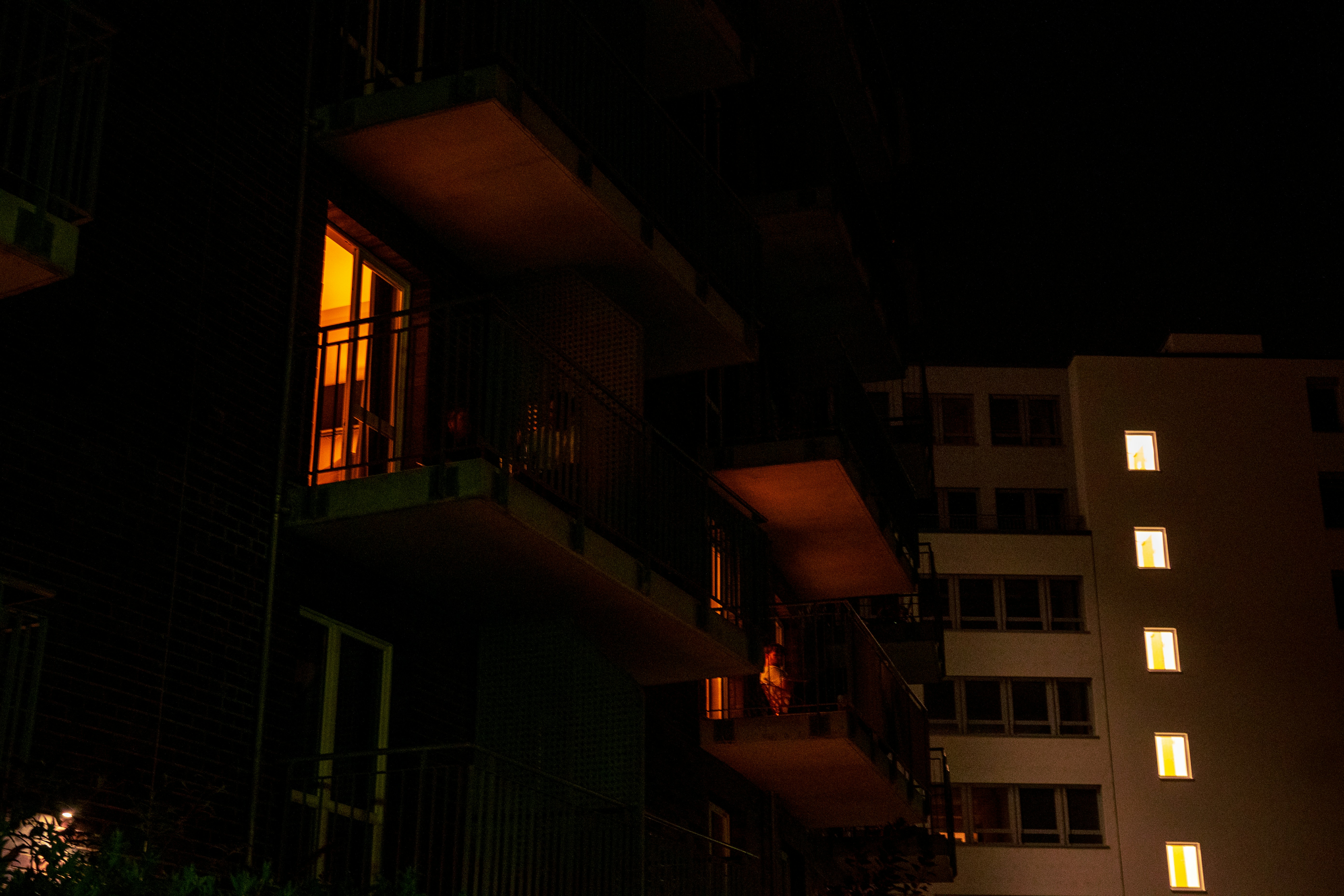 Building at night, windows glowing in the dark.