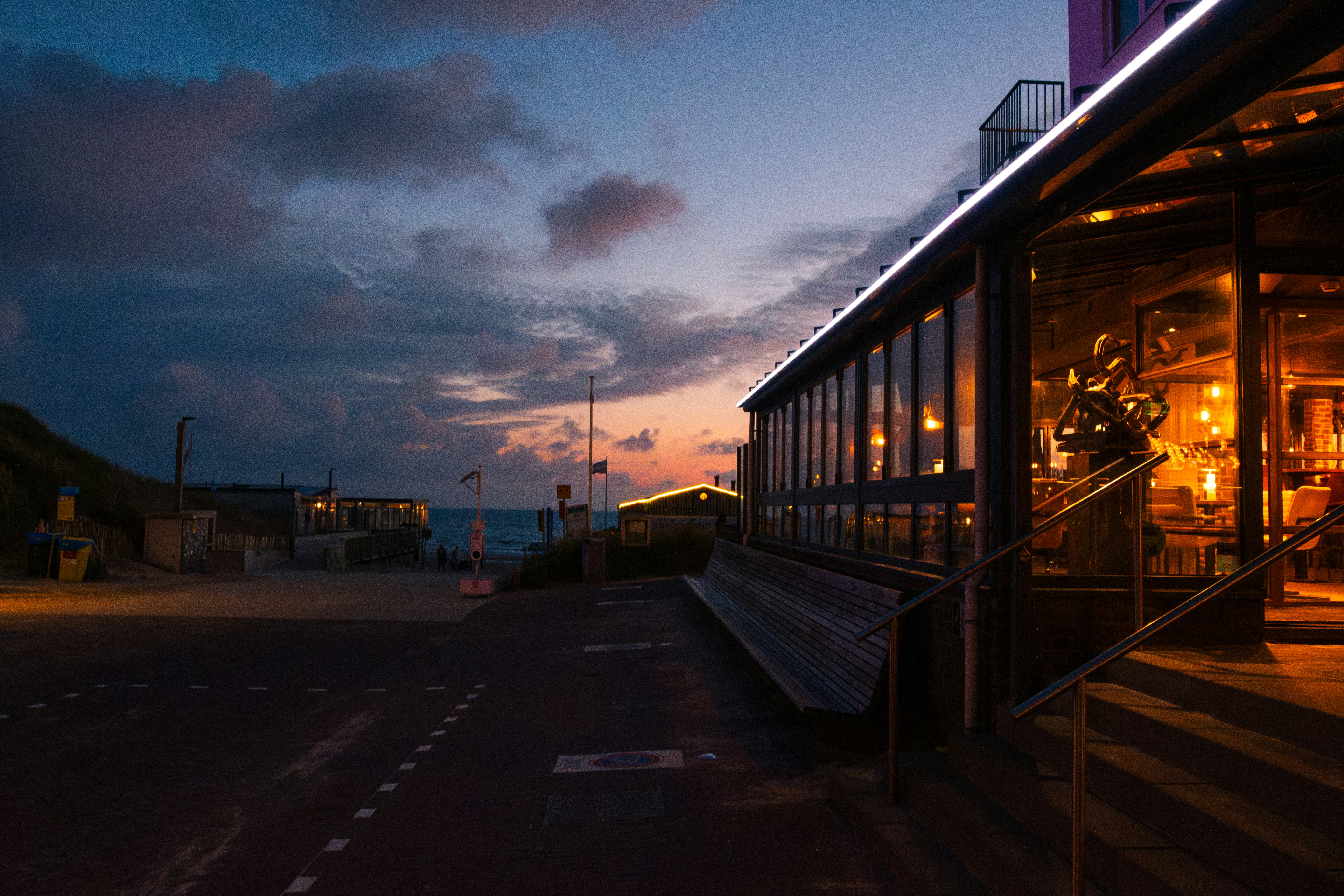 Restaurant lights up against a dusk sky.