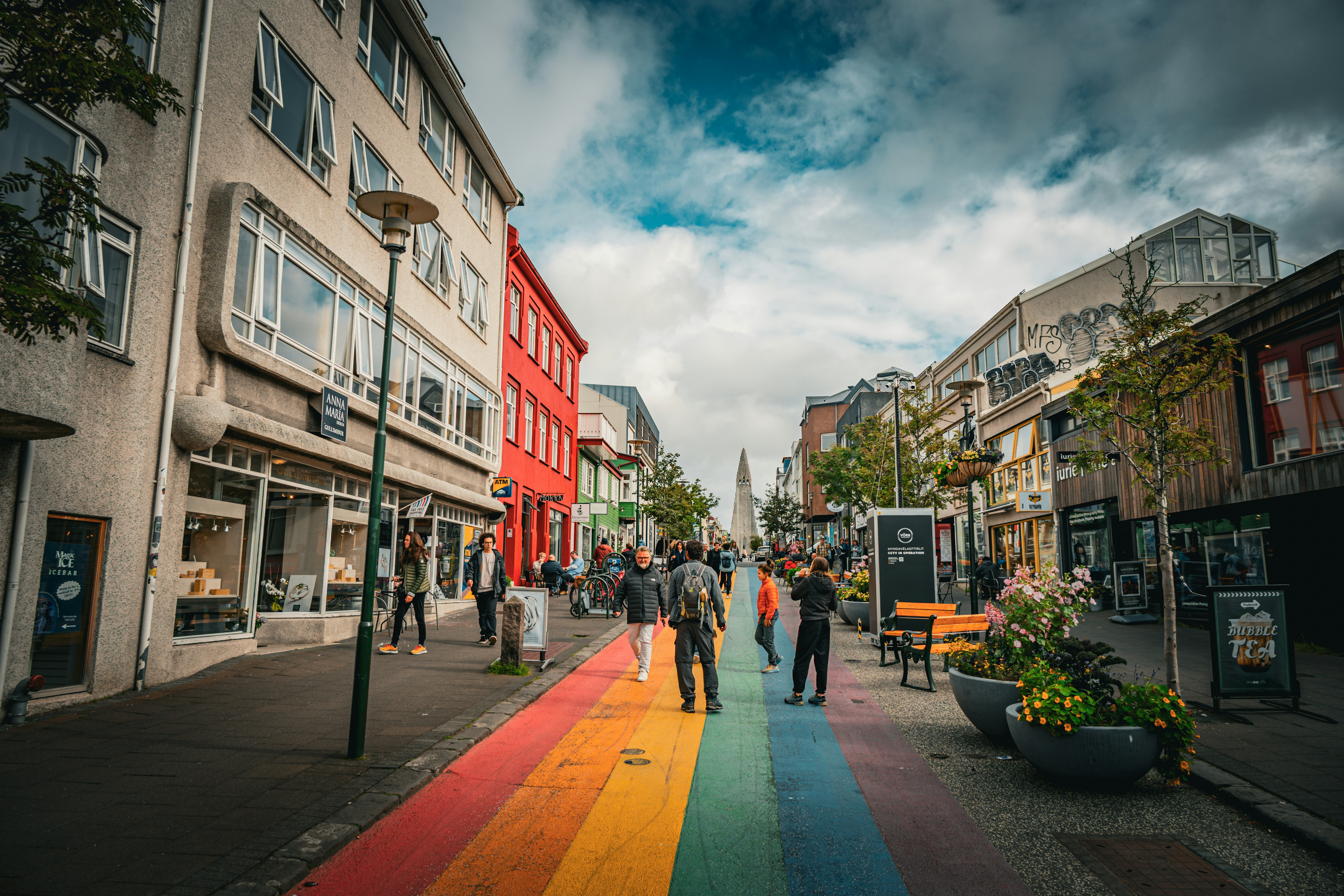 Rainbow Crosswalk Threads Color Through a Bustling City Street