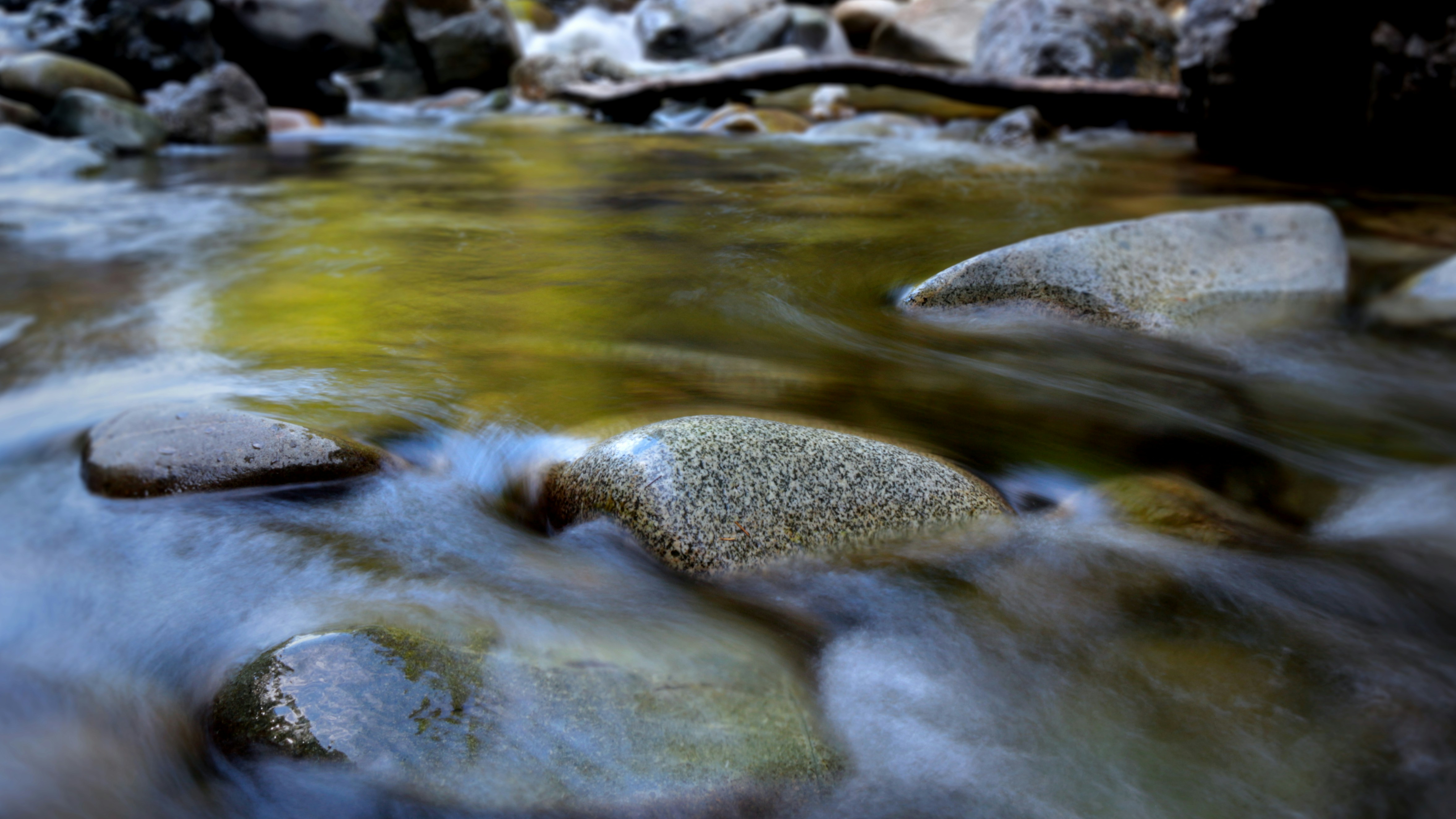 Flowing water cascades over rocks in a river. photo – Free River Image ...