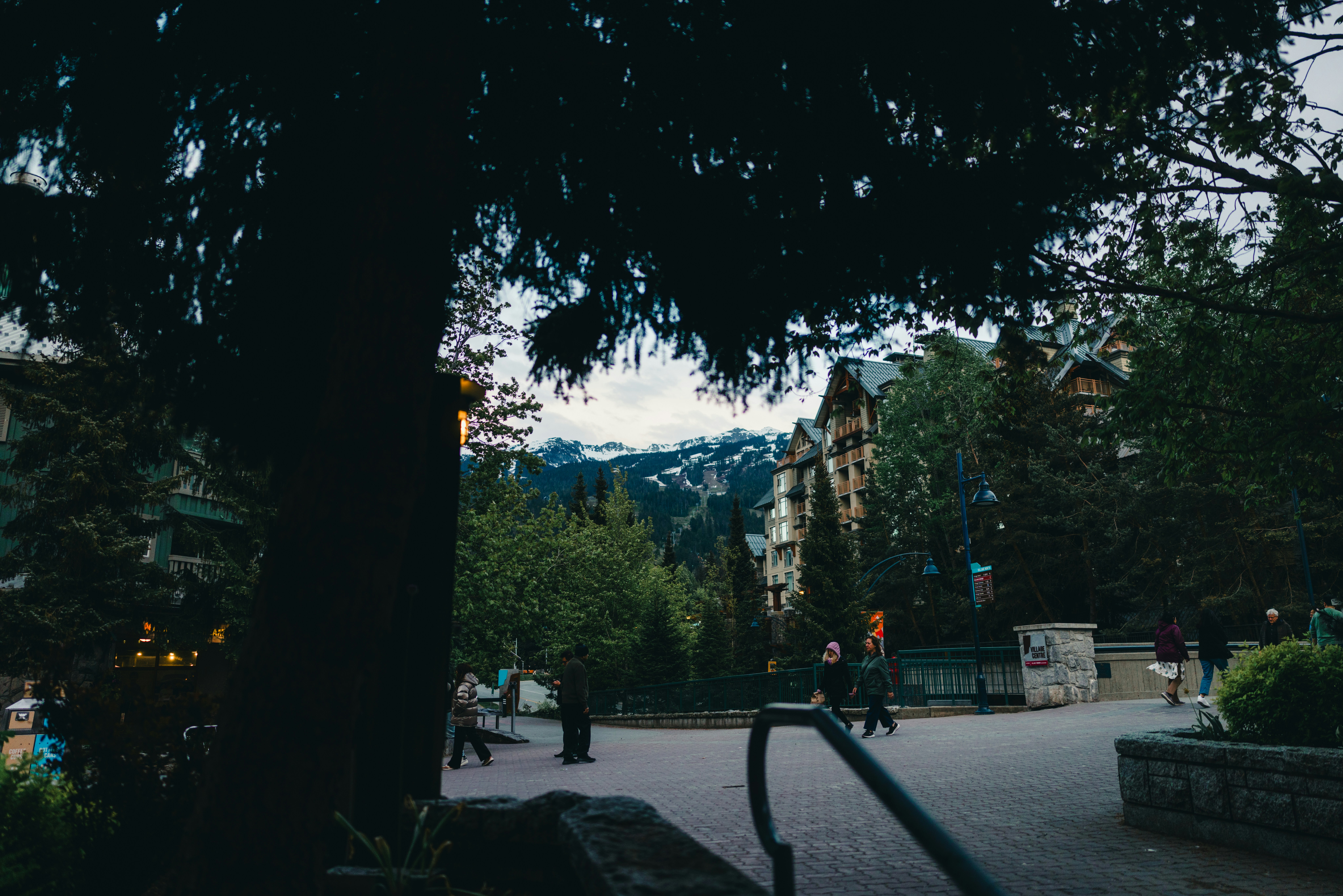 I miss Vancouver so much | A cloudy mountain view with buildings and trees.