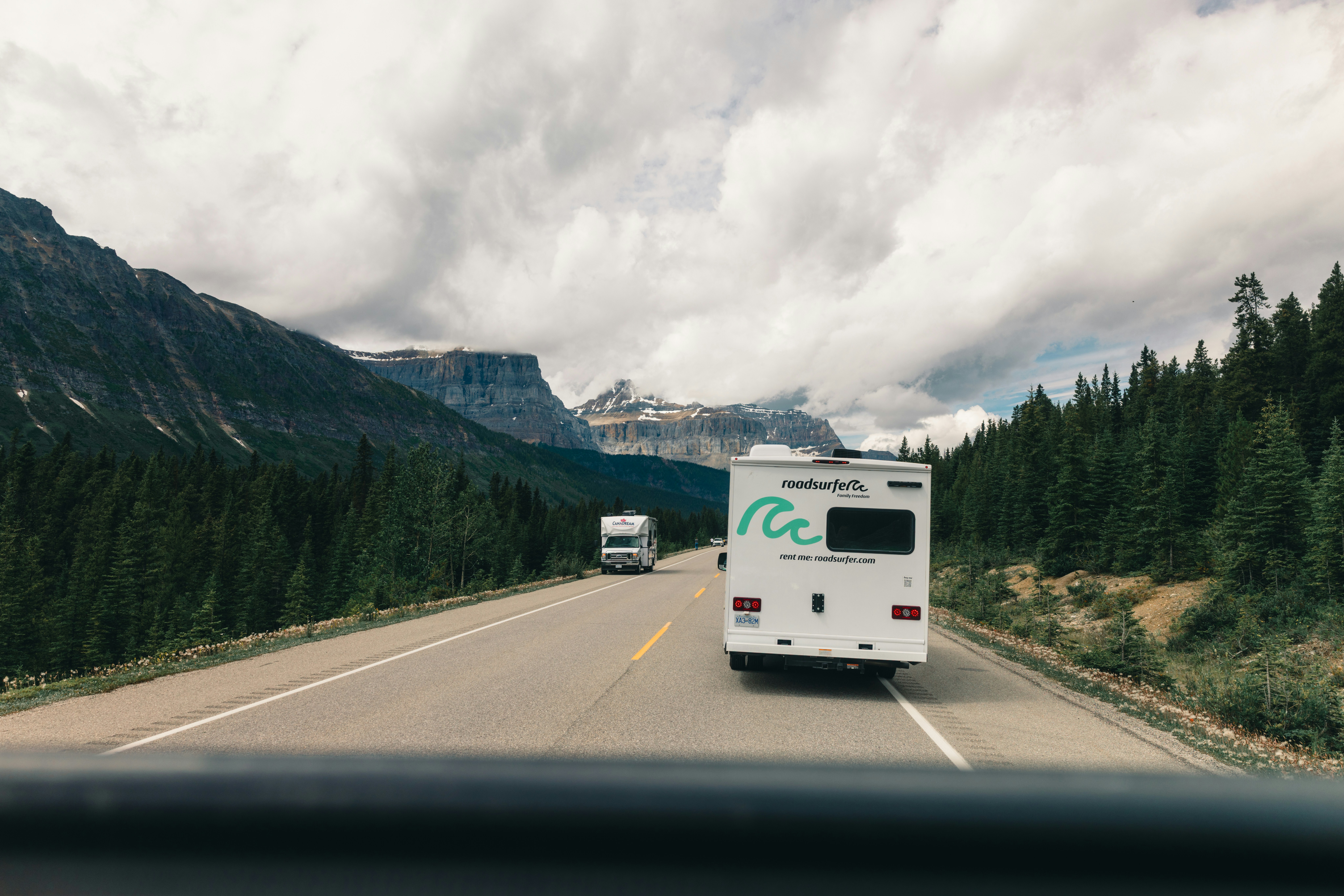 Jasper is my favourite park in Canada | Two rvs travel down a scenic mountain road.