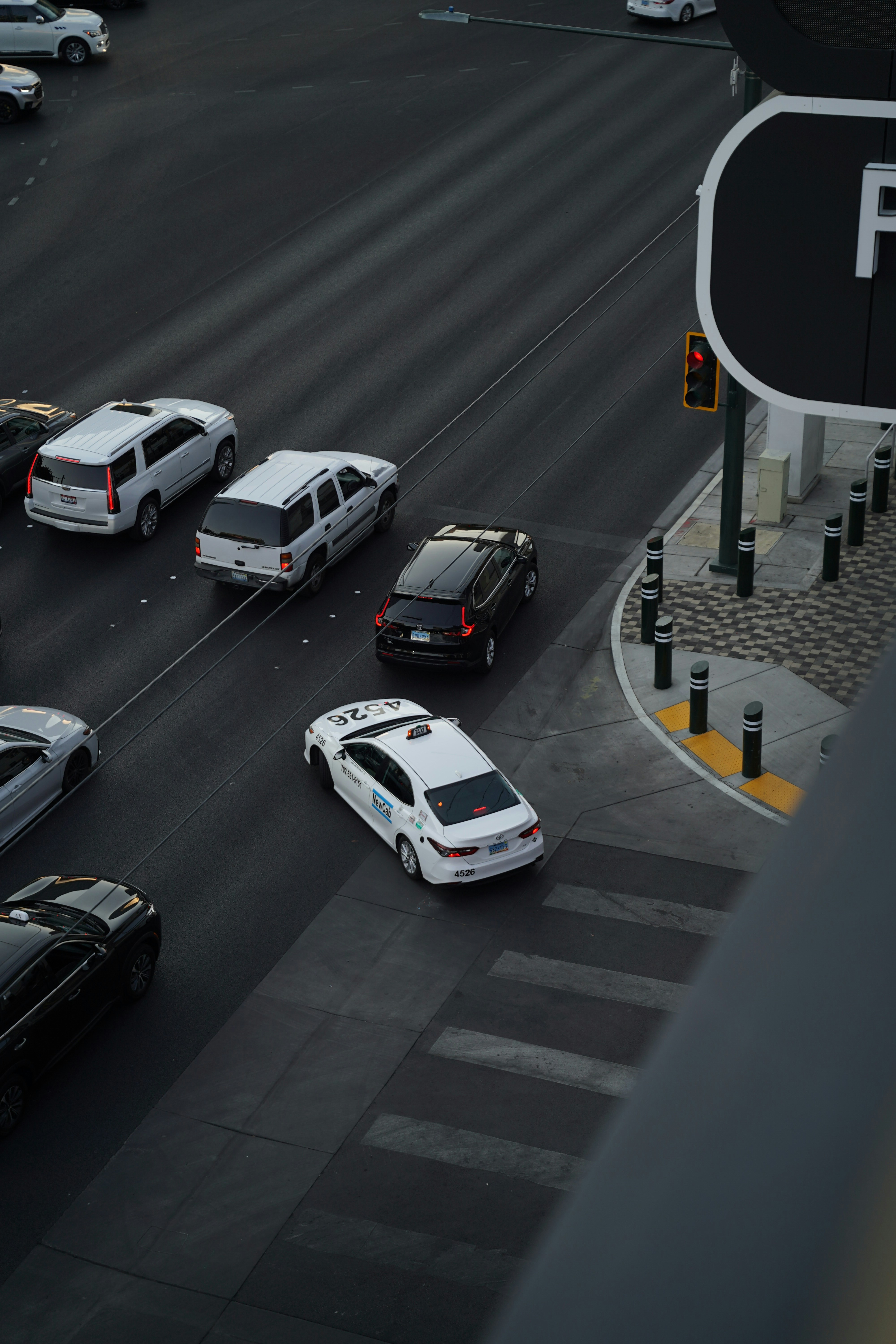 Cars are driving on a multi-lane road.