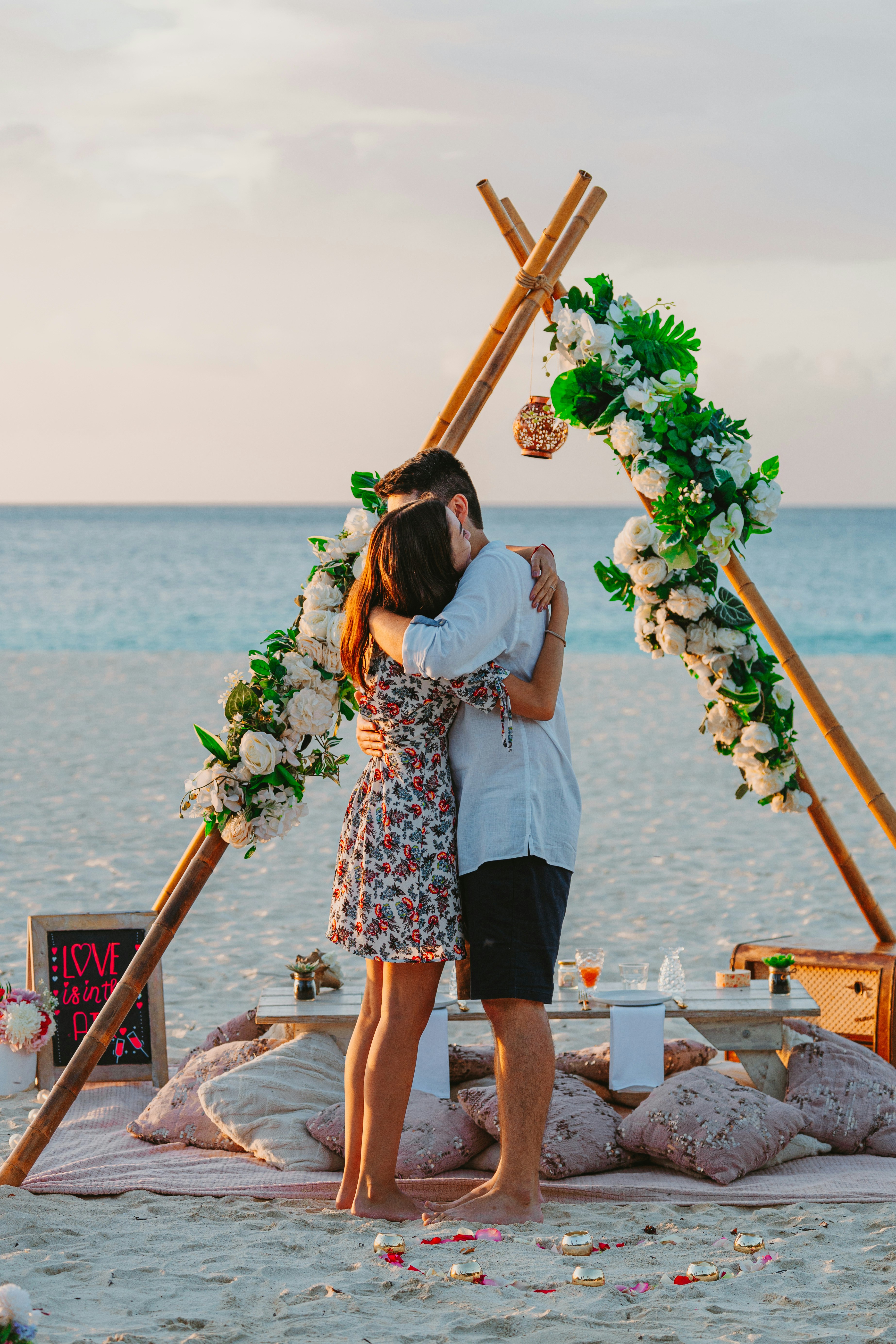 Seaside Embrace Beneath a Floral Bamboo Arch
