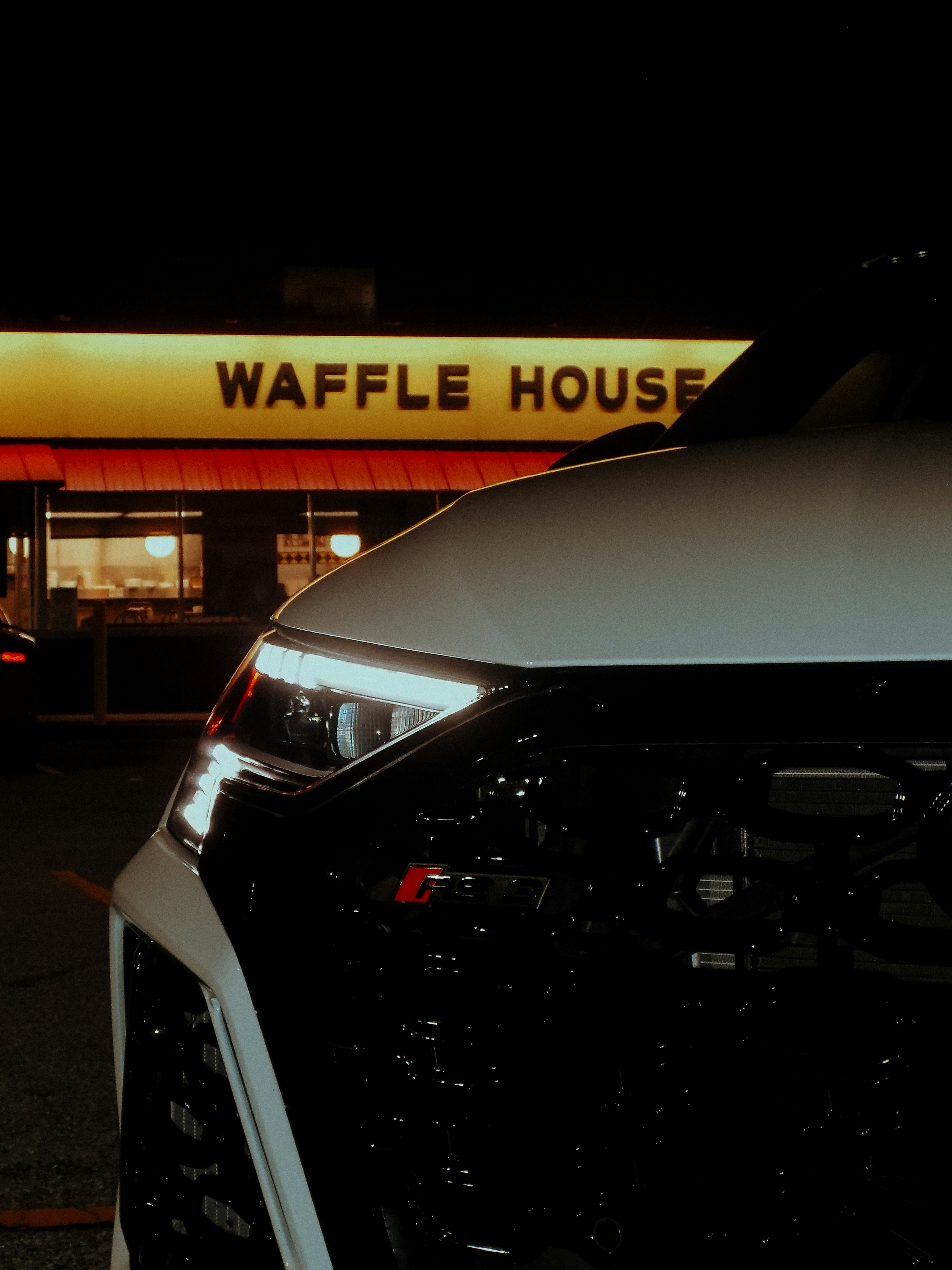 Car parked in front of a waffle house.