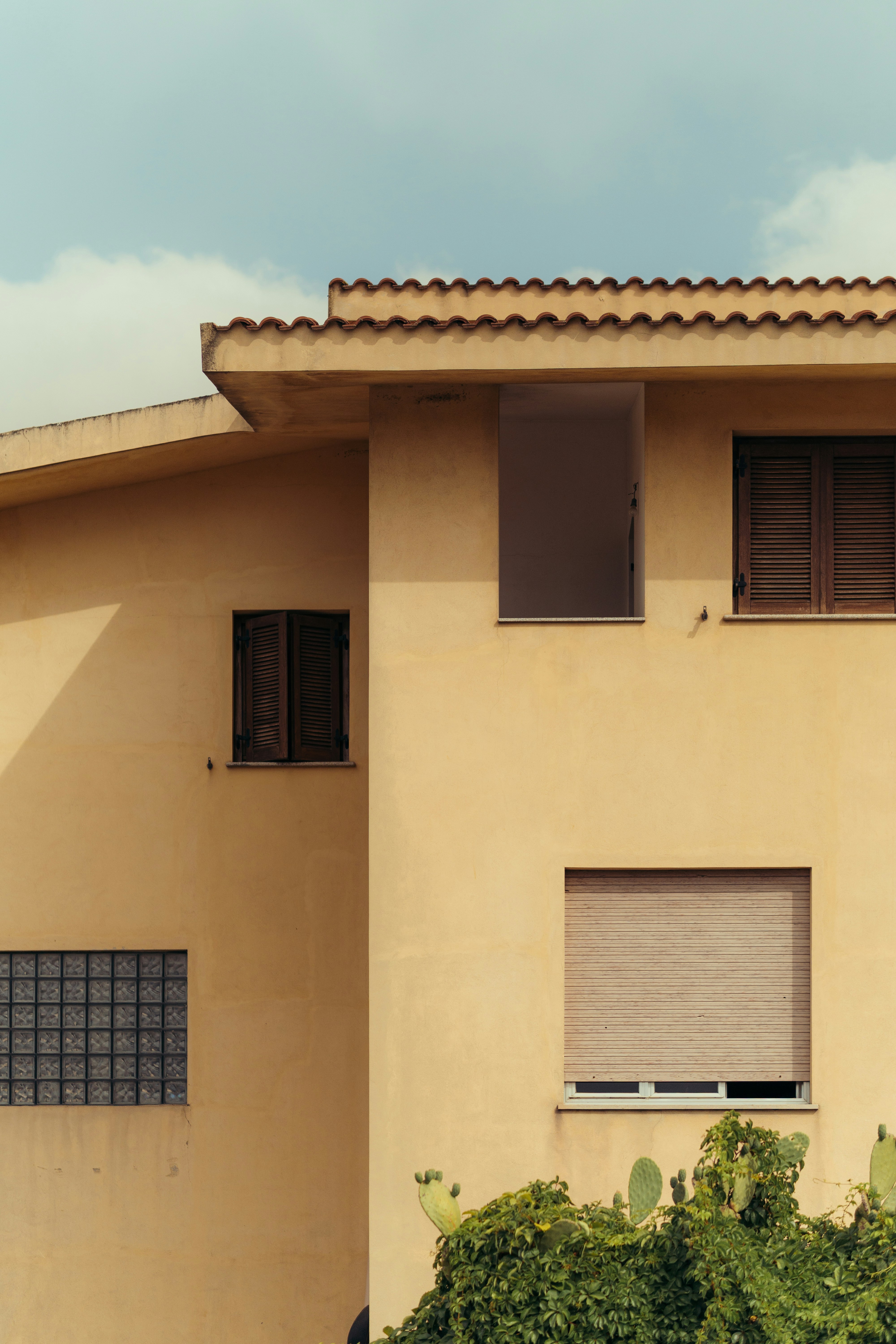A yellow building with various windows stands out.