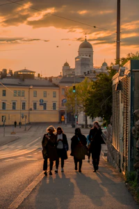Crosswalk at Dusk: Pedestrians in Long Shadows Beneath the Civic Dome