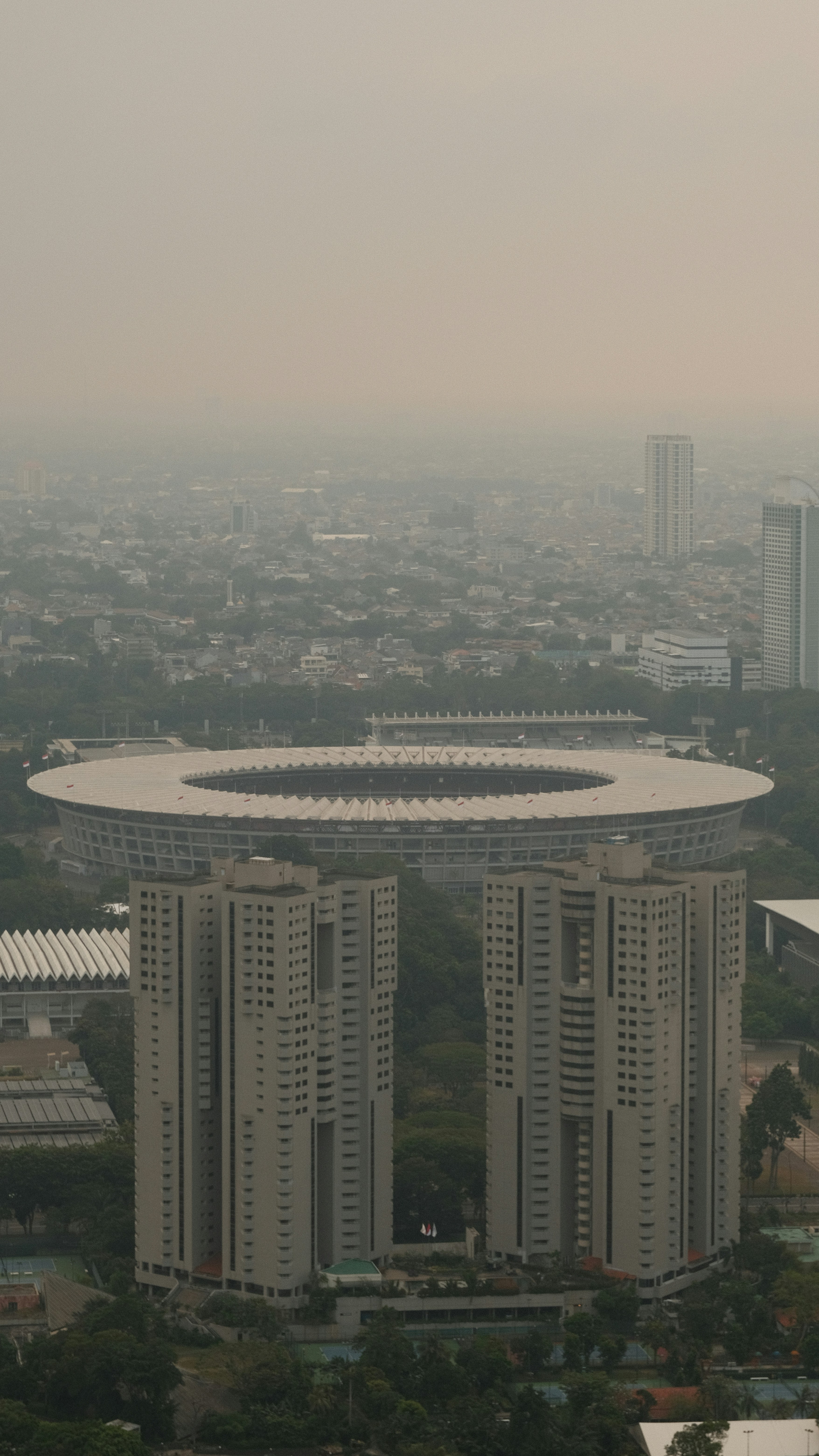 Cityscape with a stadium and two skyscrapers.