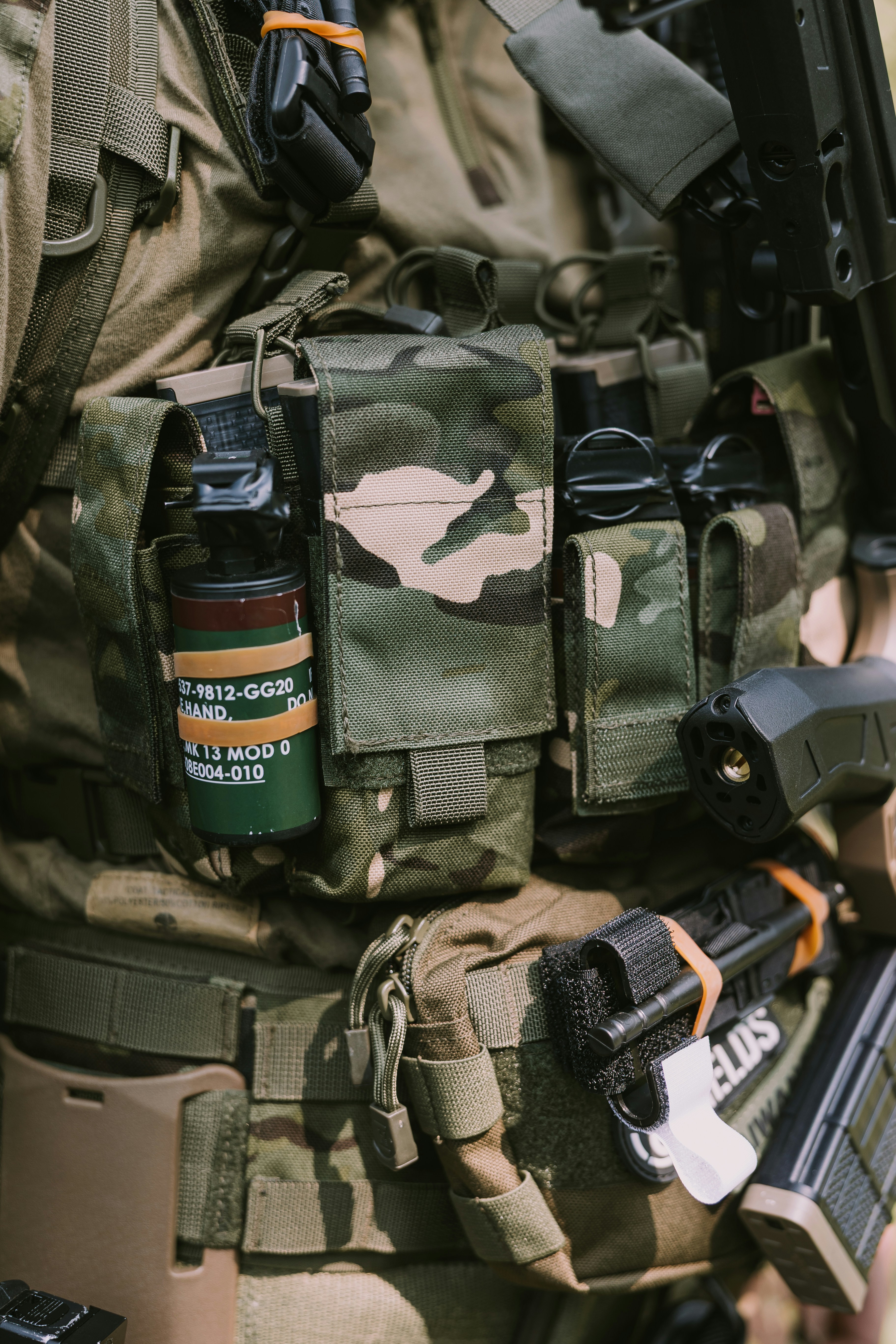 White Emblem on Camouflage MOLLE Rig: Close-Up of Tactical Readiness