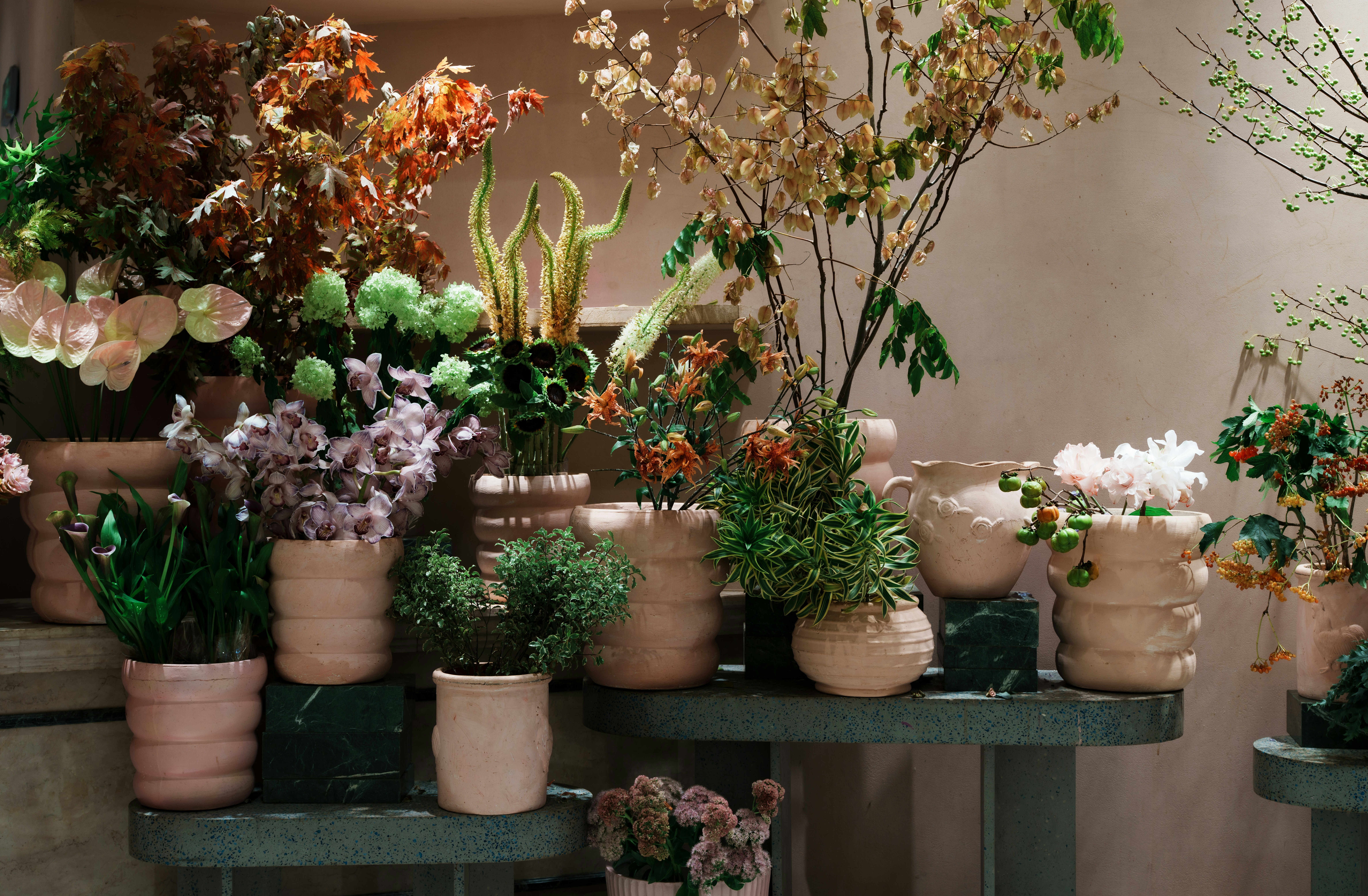 Beautiful flower arrangements are displayed on shelves.