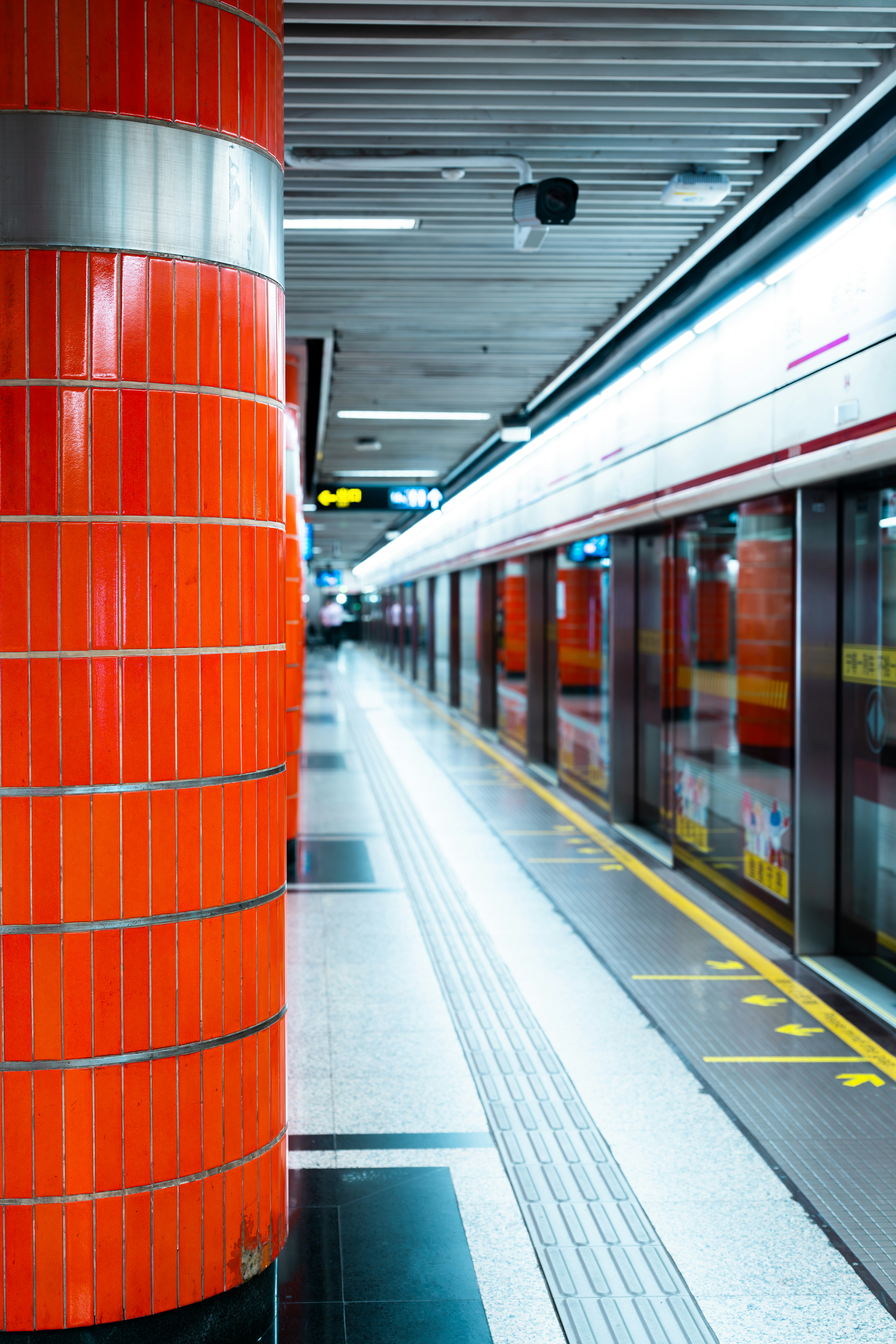 A subway platform awaits passengers at a station.