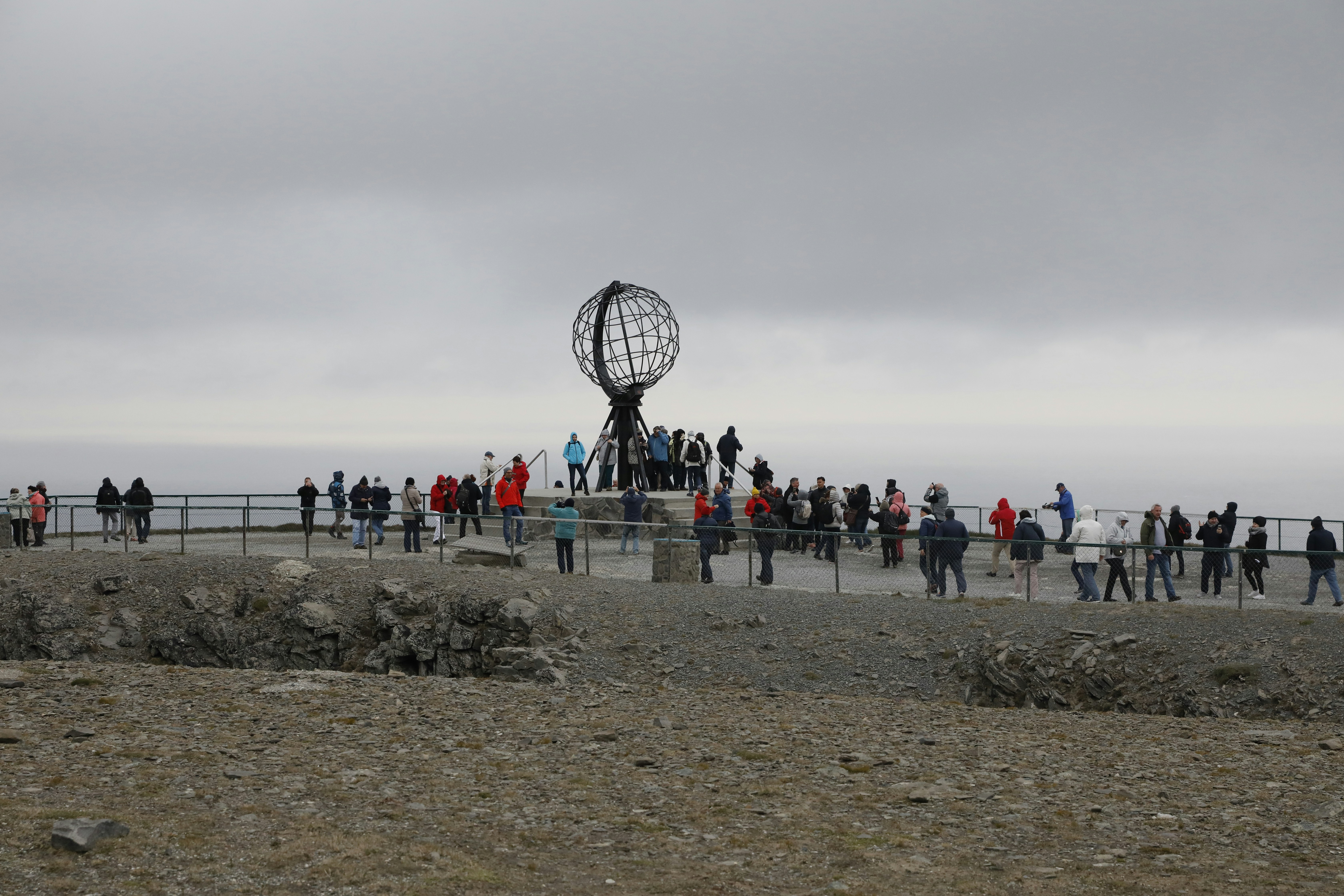 Nordkap, Nordkapp, North Cape Norway | People gather near a globe-shaped monument.