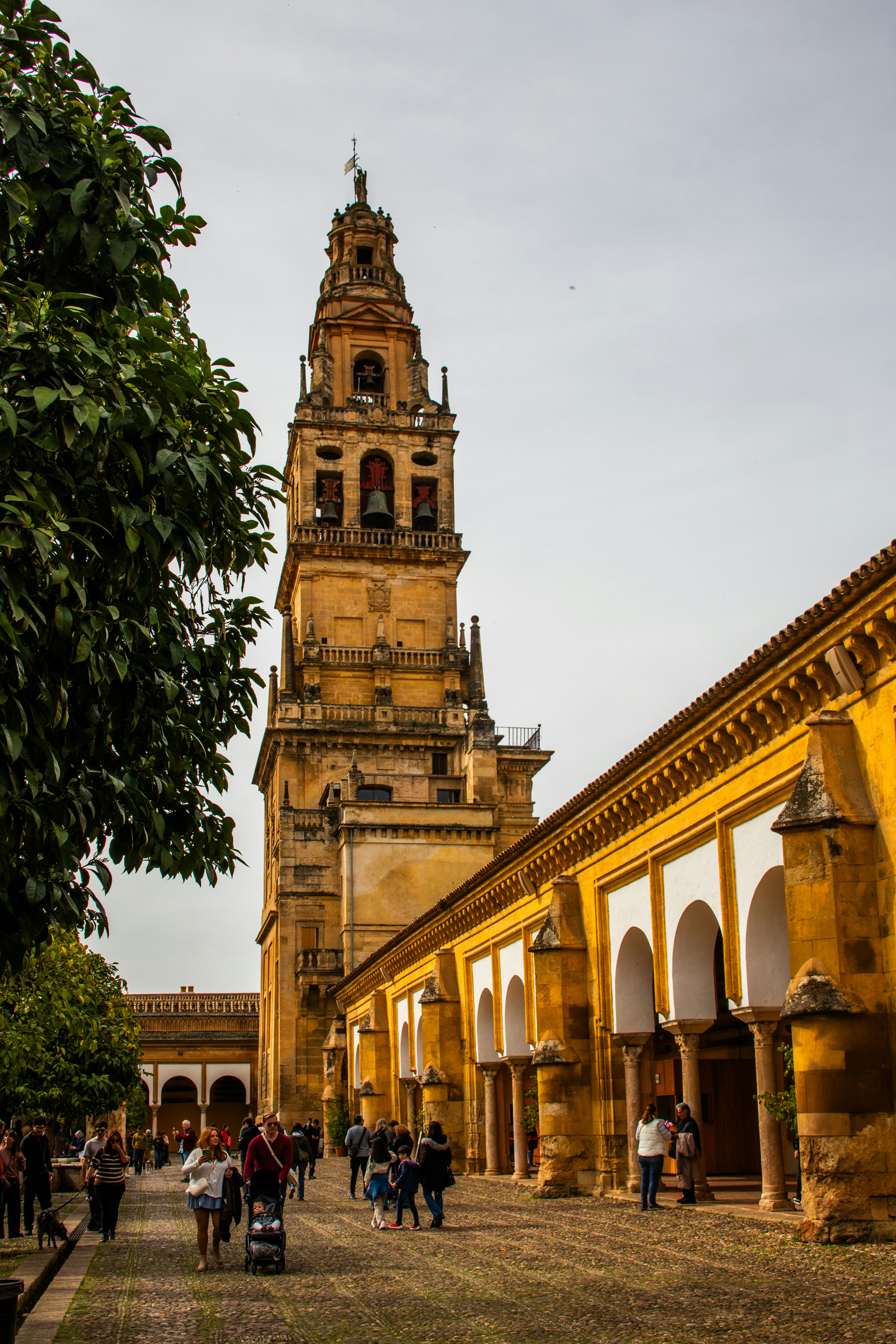 A tall tower adorns a beautiful spanish building.