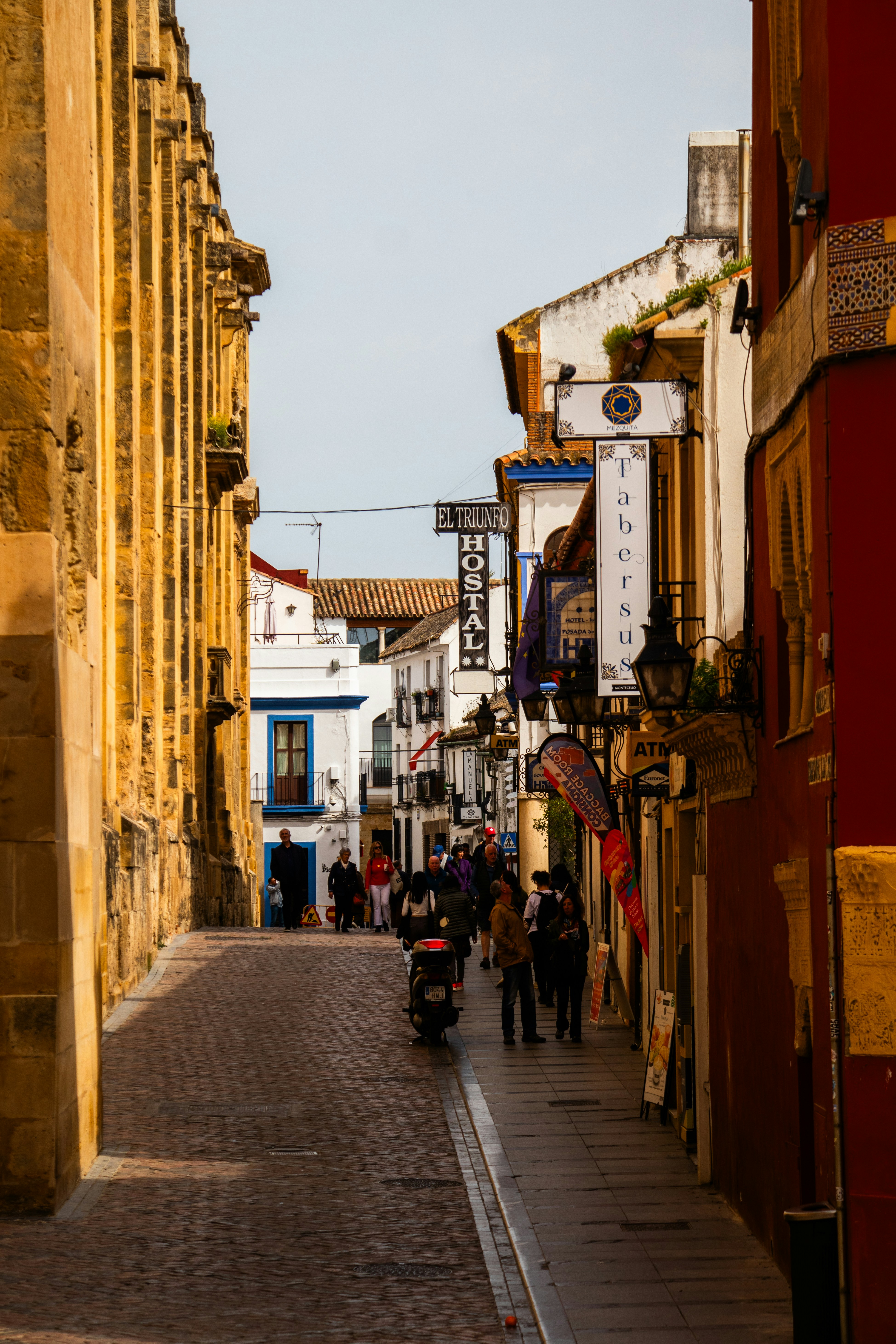 Narrow cobblestone street lined with buildings.