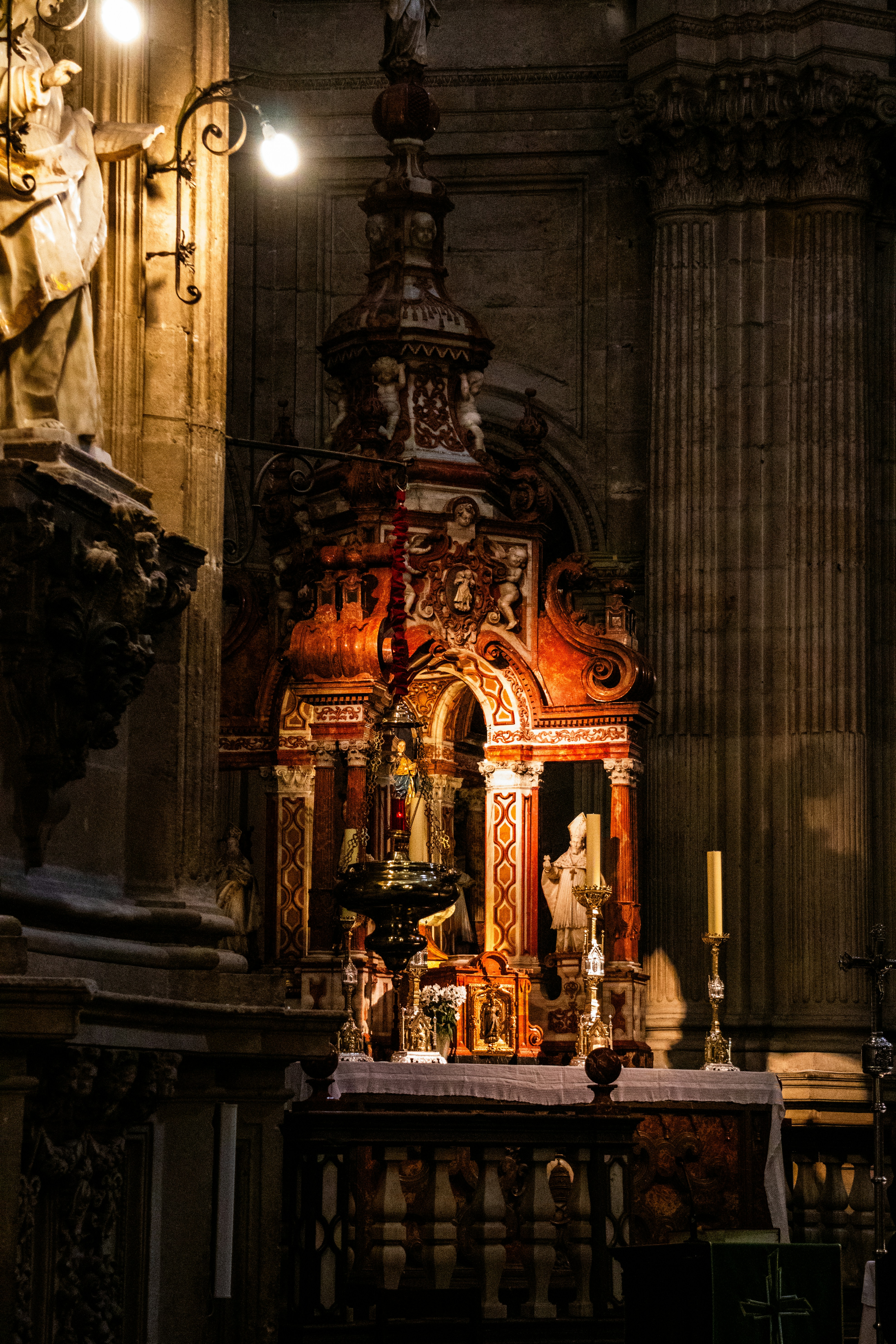 A detailed altar illuminated in a church.
