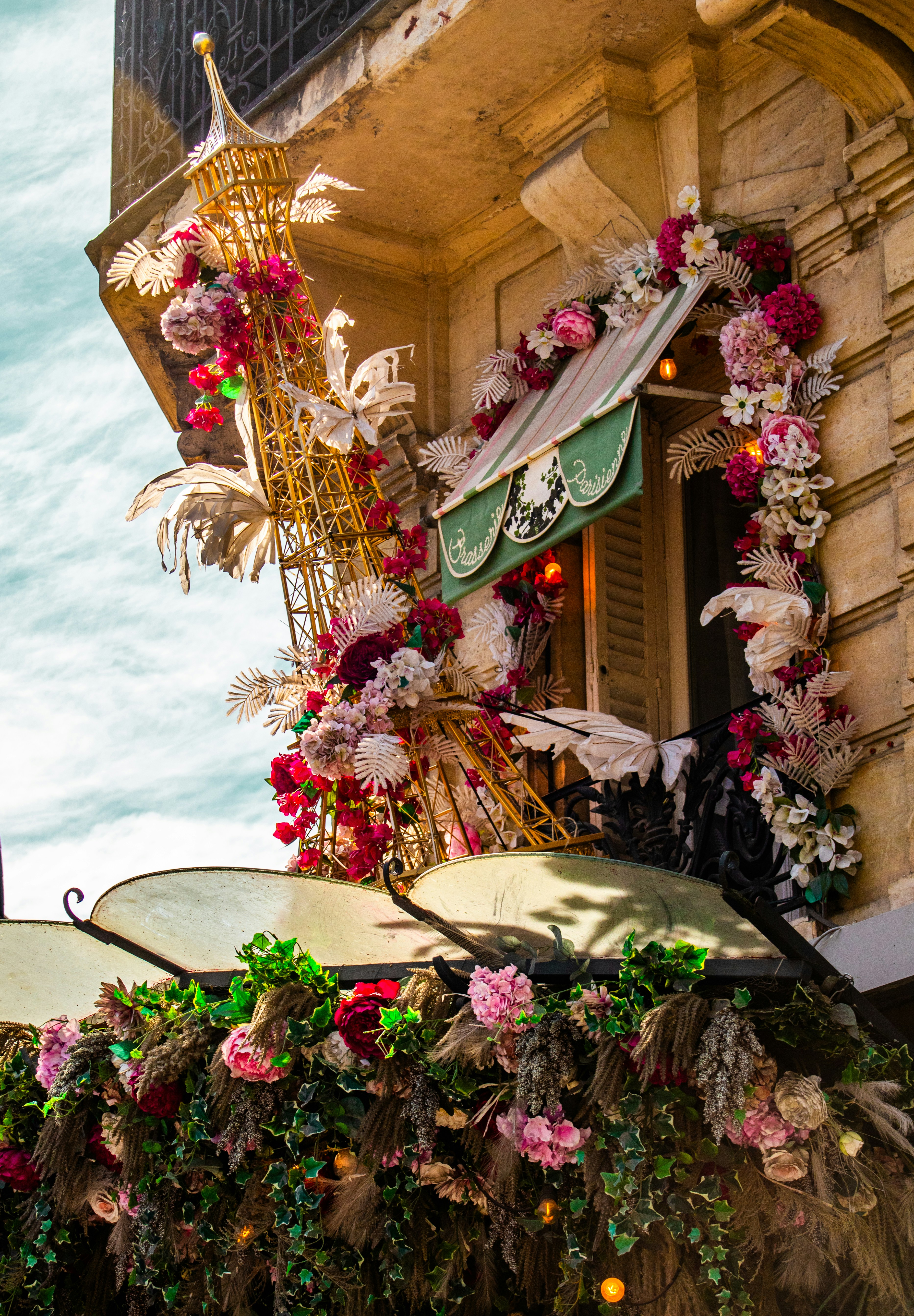 Floral Balcony Crane: A Parisian Florist's Facade Bloom