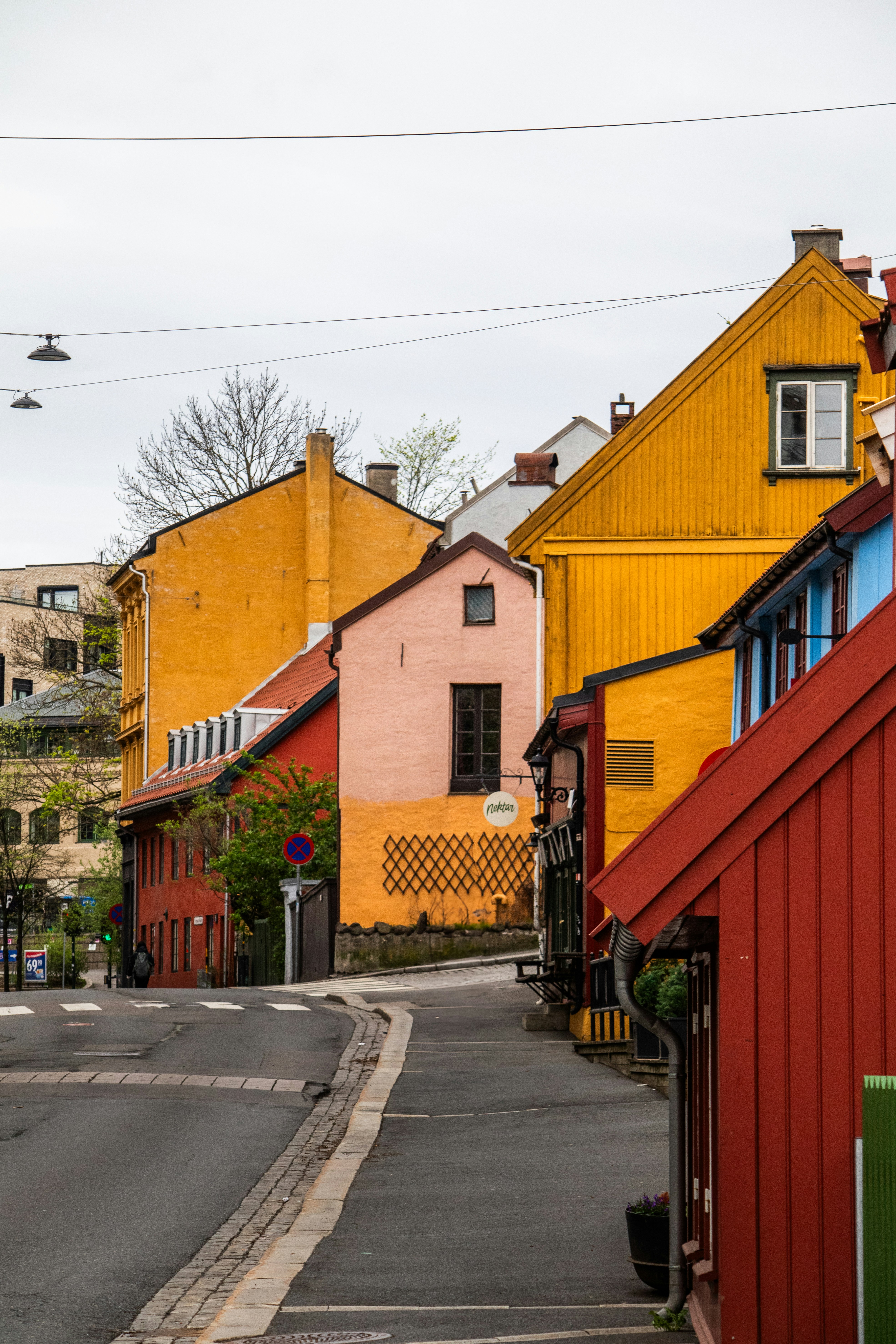 Colorful buildings line a winding street.