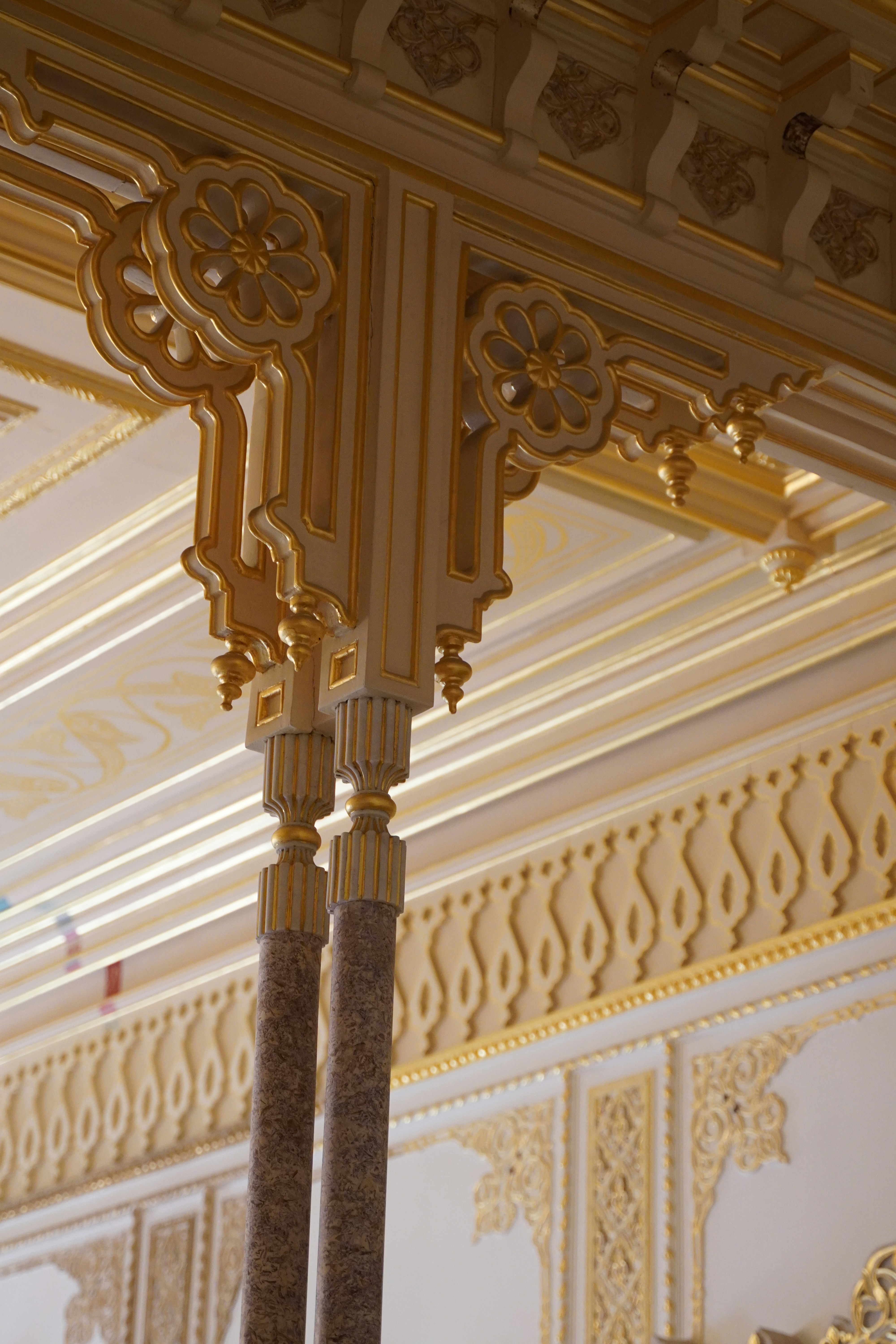 Gold-gilded architectural details adorn the ceiling.