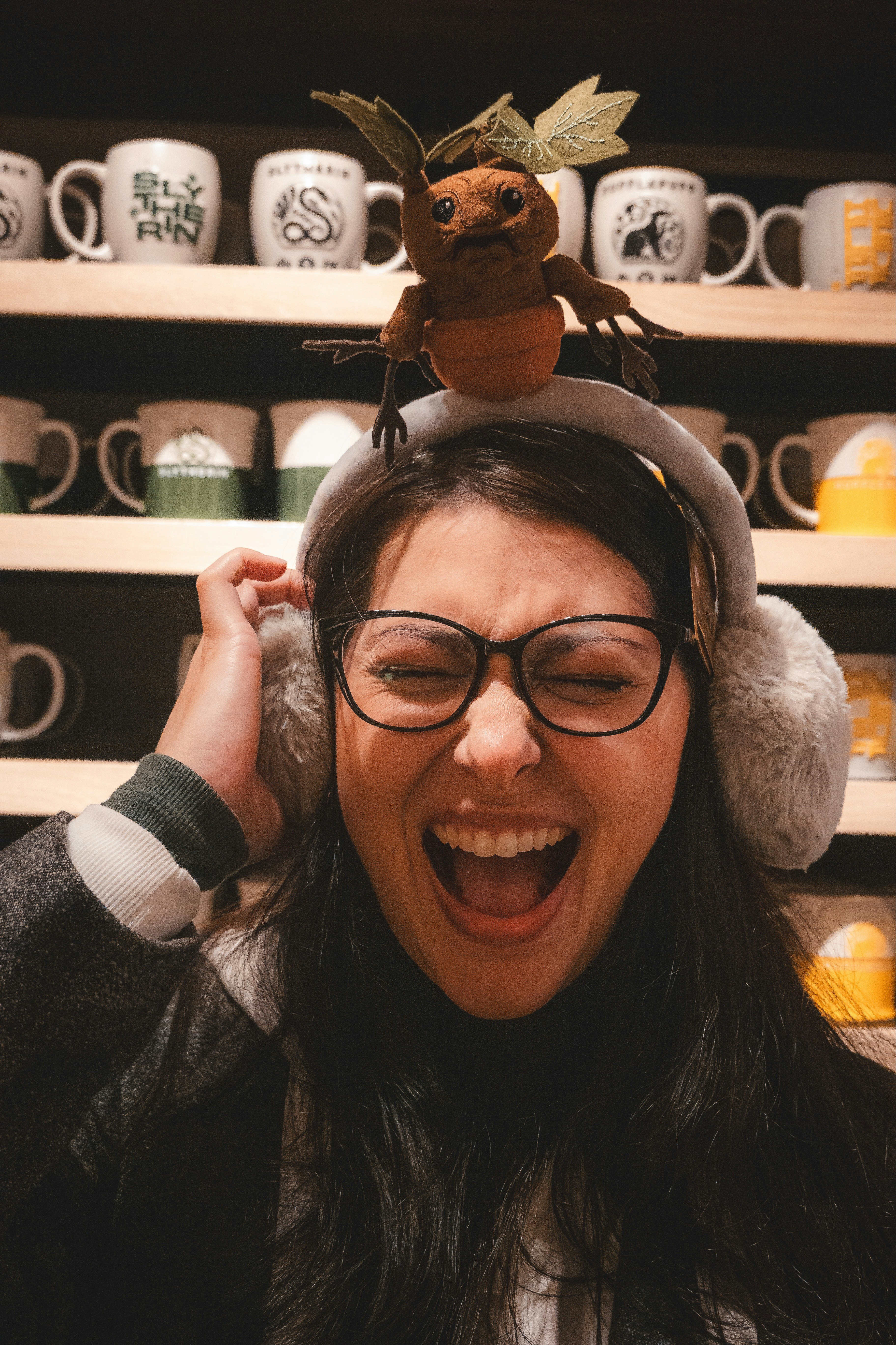 Woman screams while wearing a mandrake on her head.