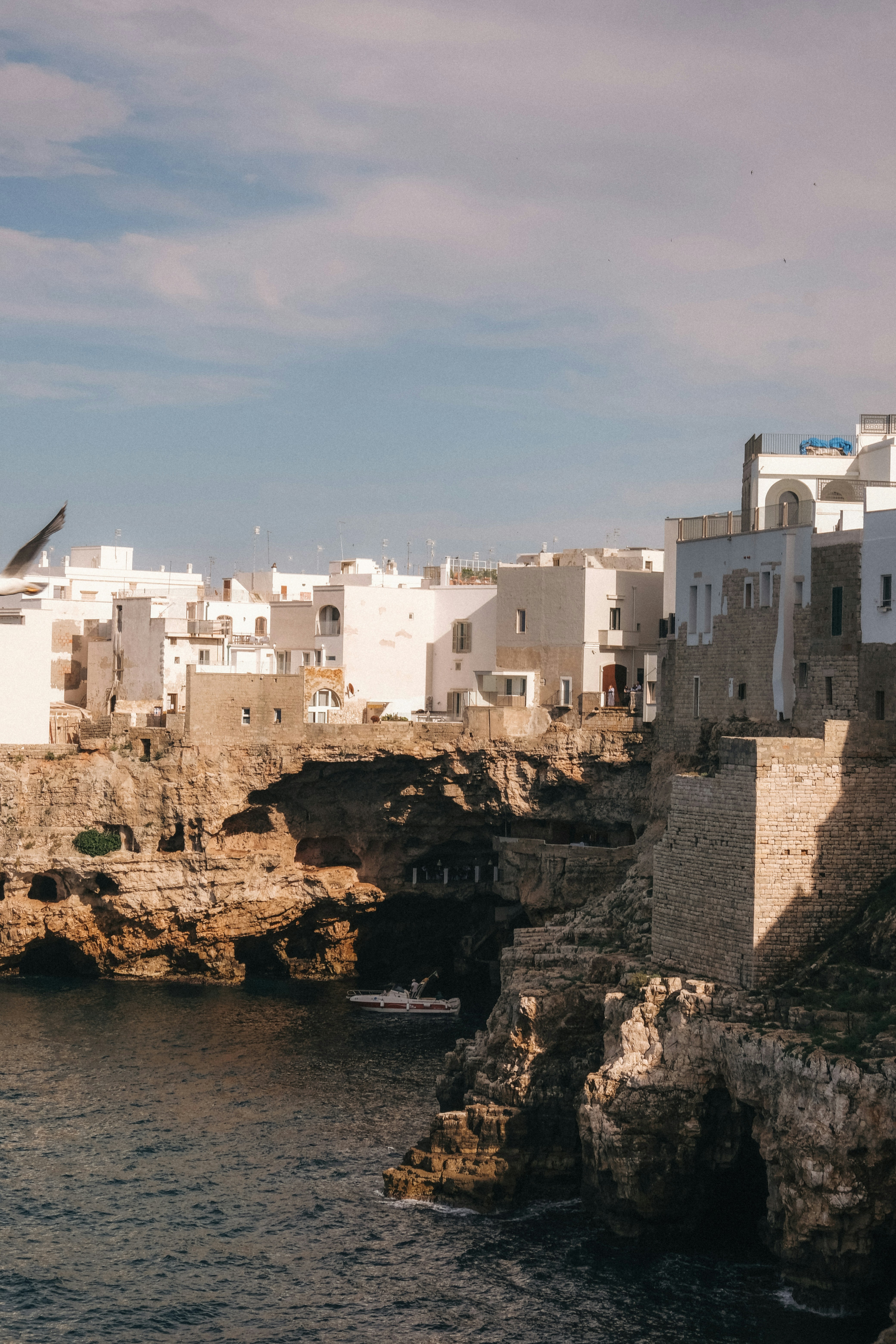 Coastal town with buildings built into the cliffs.