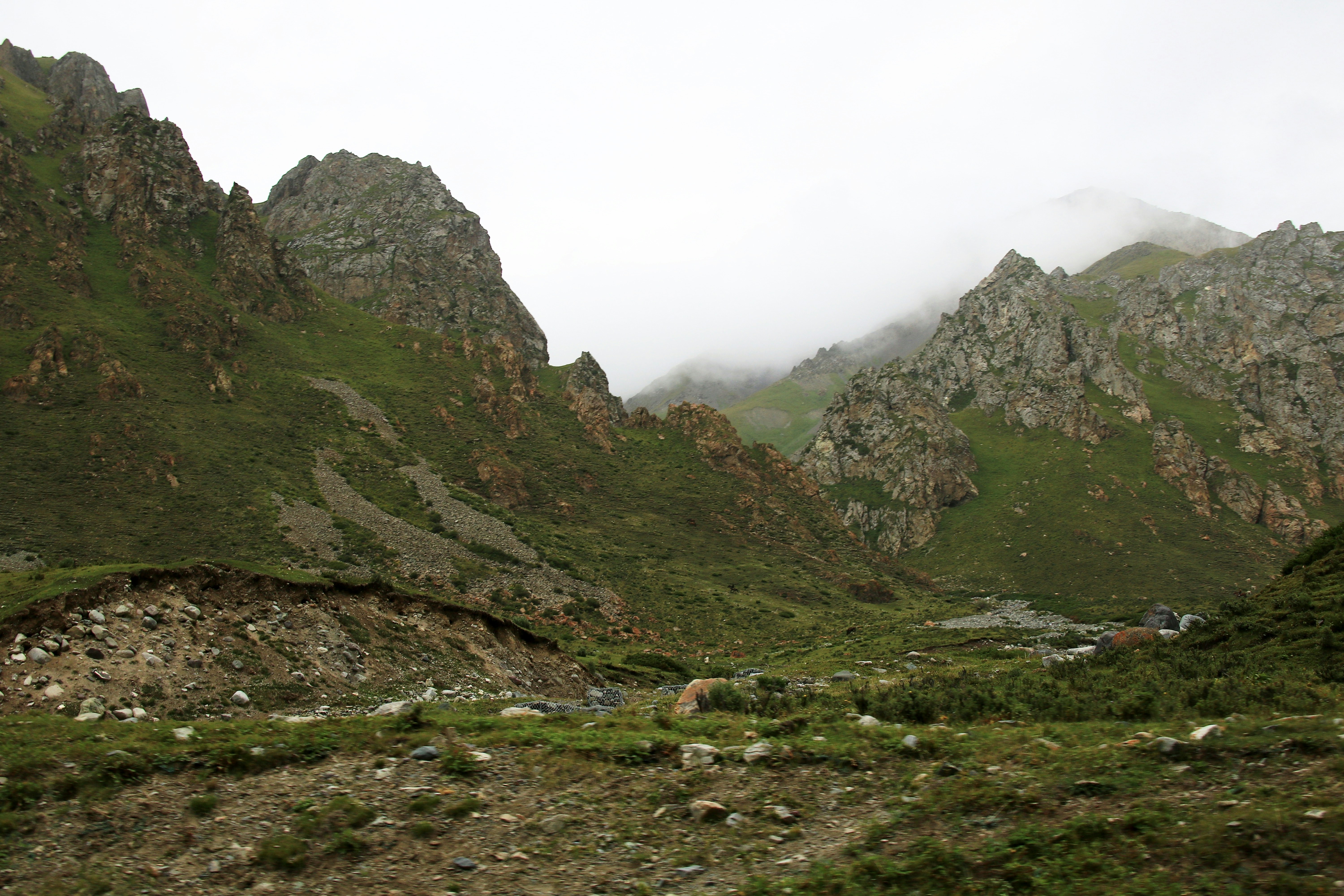 Rocky mountains under a cloudy sky.