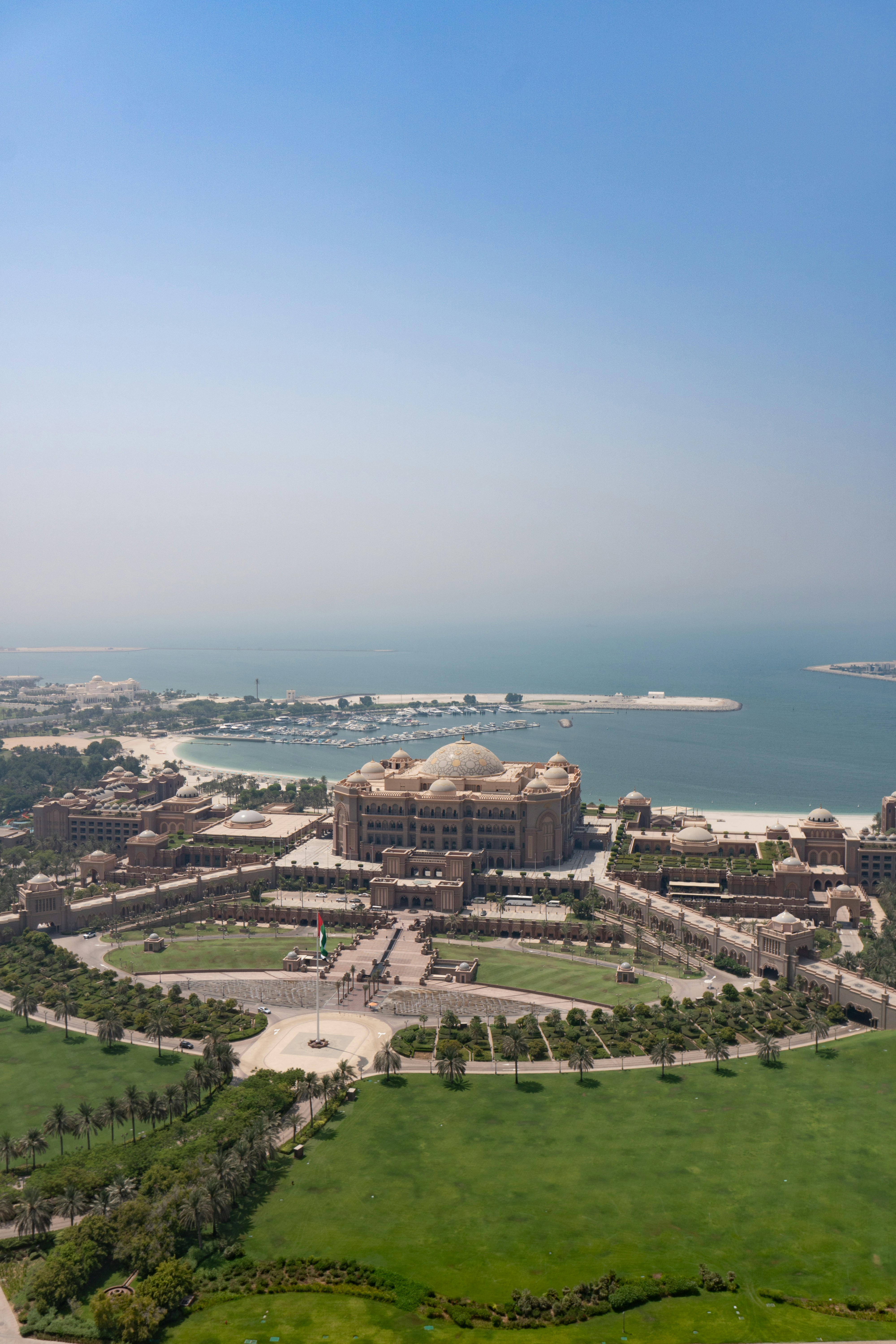 An aerial view of a lavish hotel and coastline.