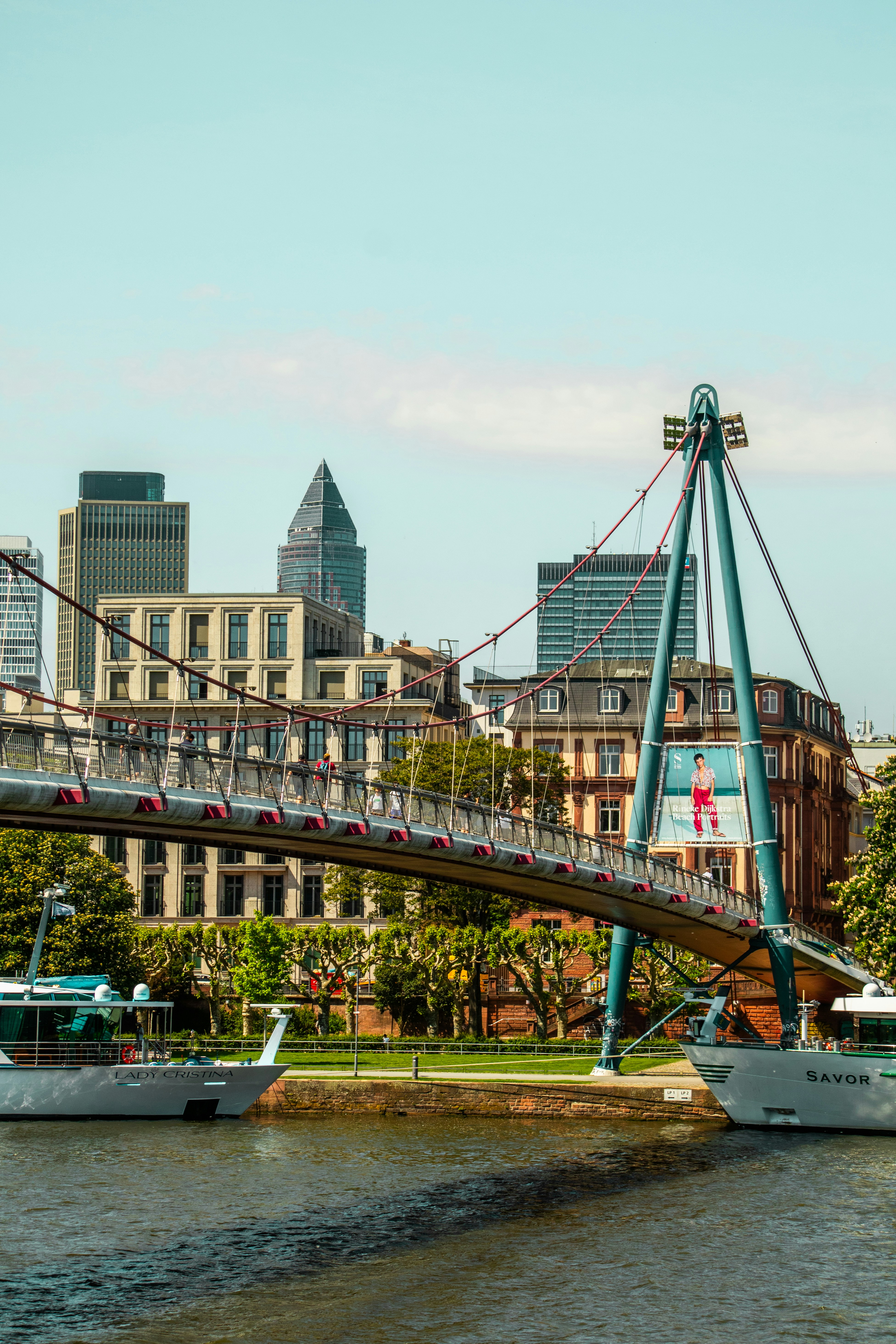 Bridge over water with city buildings in the background.