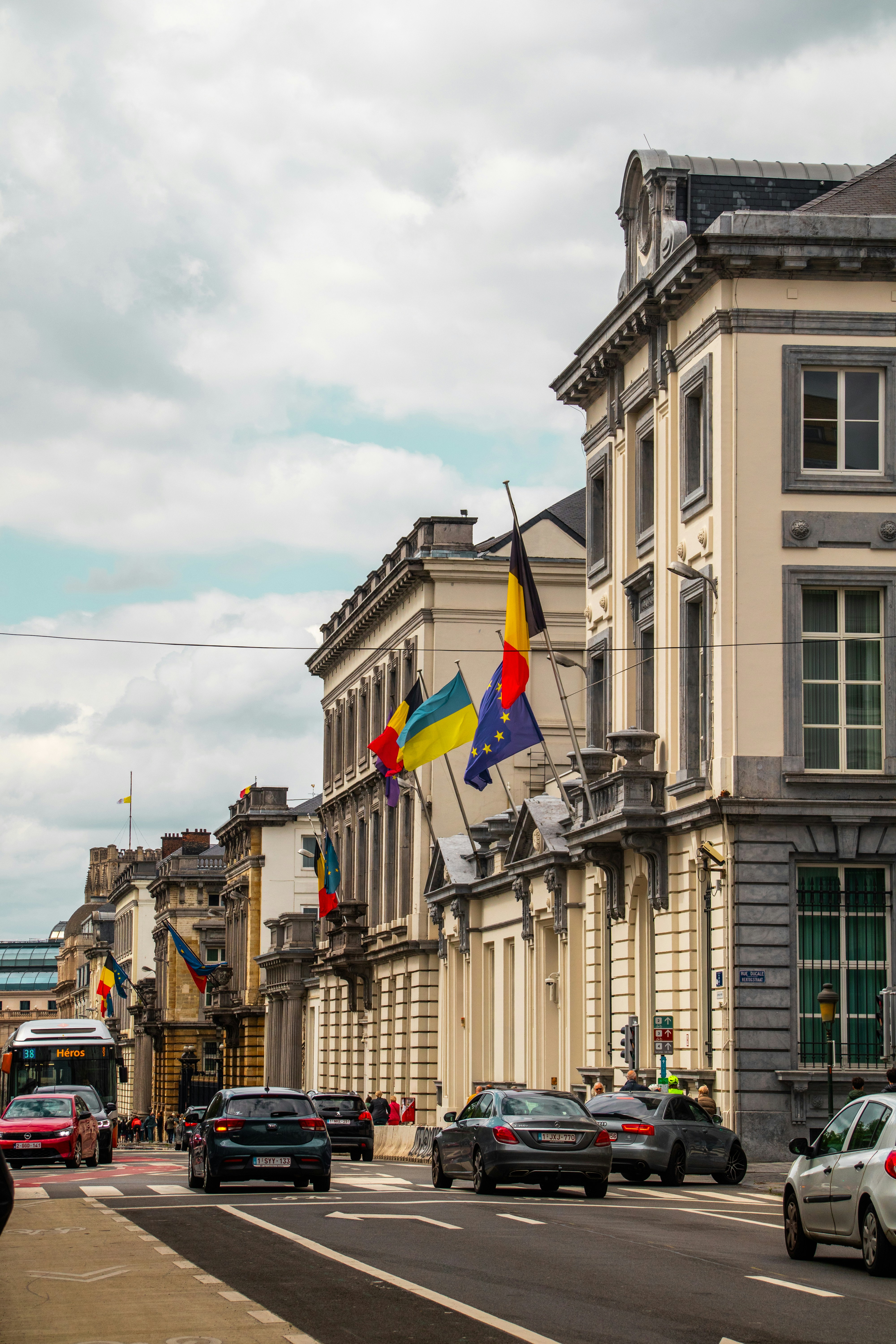 Street in belgium with buildings and flags.