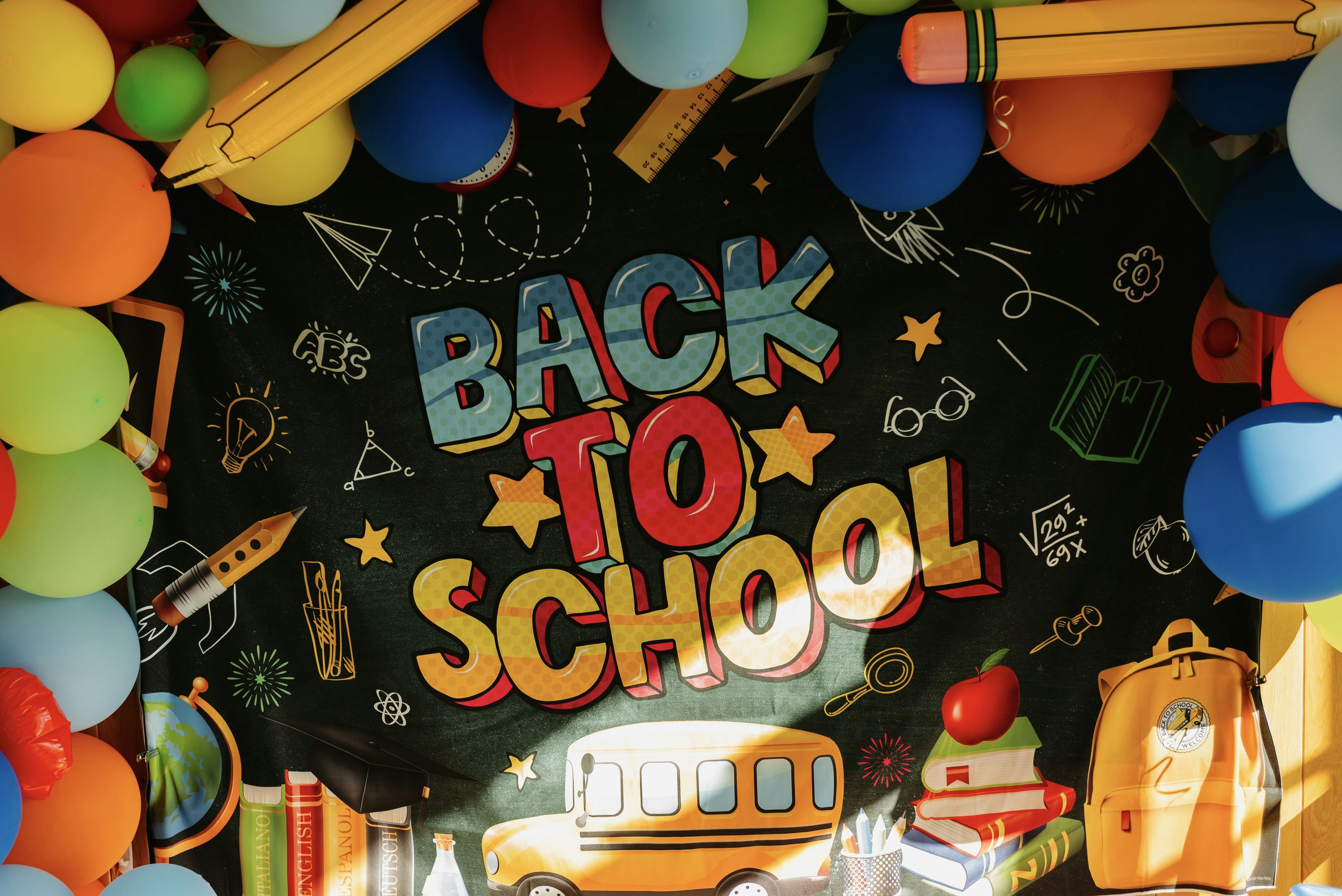 Back to school sign with balloons and decorations.